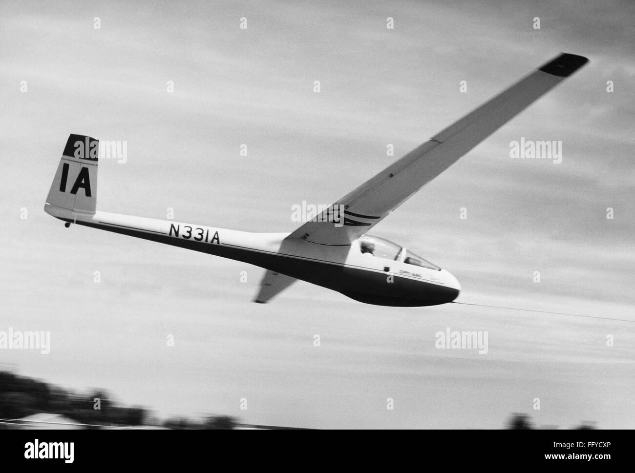 GLIDER COMPETITION. /nA single-seat glider in flight during a ...