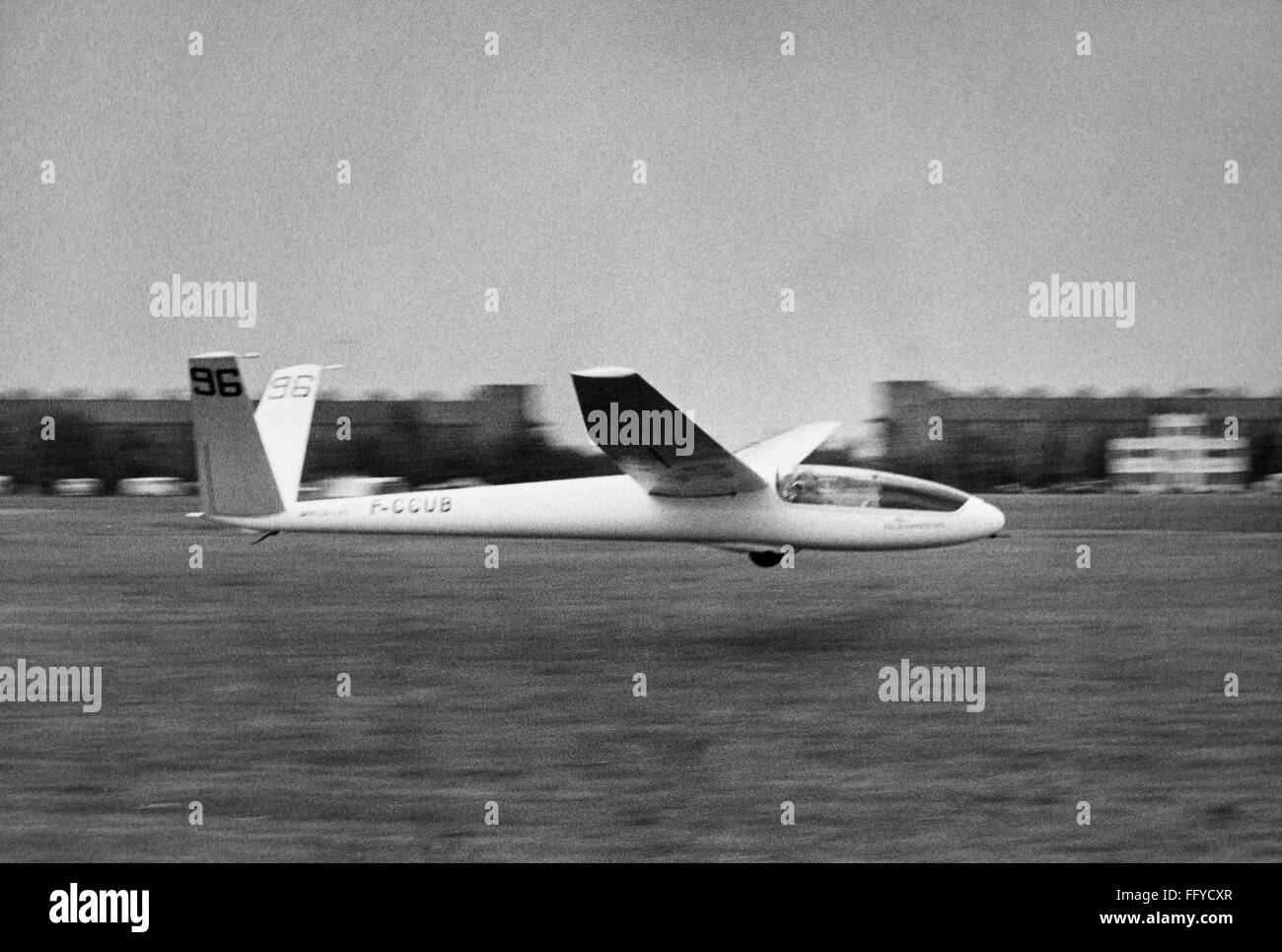GLIDER COMPETITION. /nA single-seat glider in flight during a ...