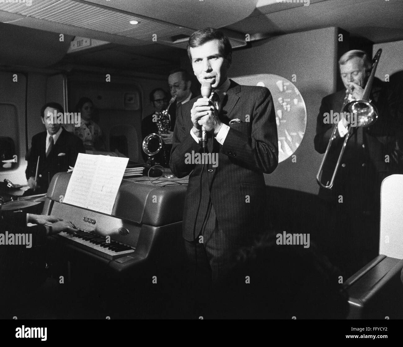 AMERICAN AIRLINES LOUNGE. /nA band and a singer performing in the piano ...