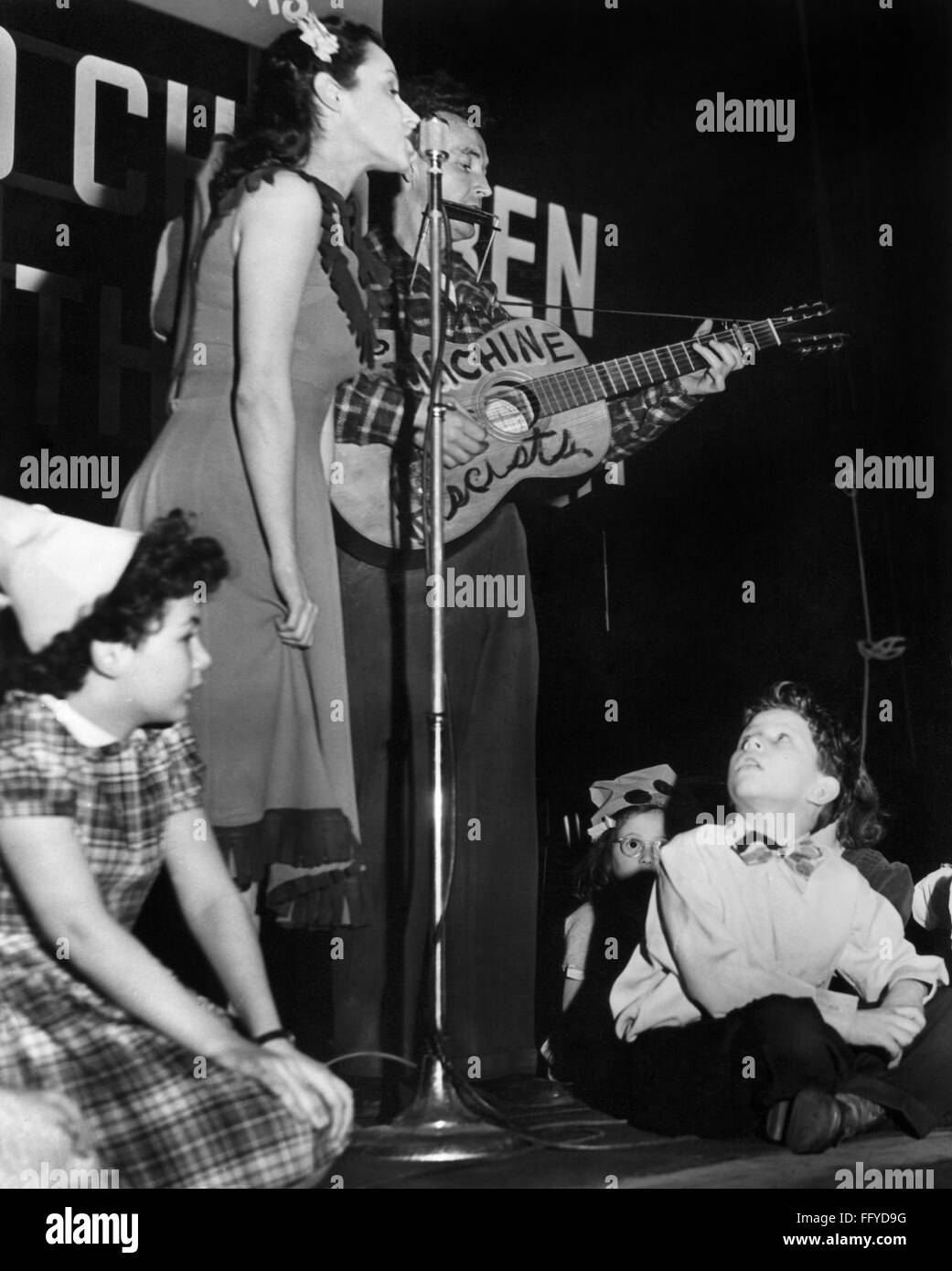 WOODY GUTHRIE (1912-1967). /nAmerican folk singer, leading children in ...