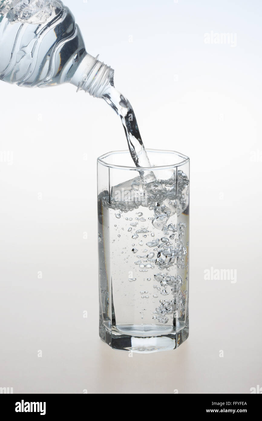 Pouring water in transparent crystal glass ; India Stock Photo - Alamy