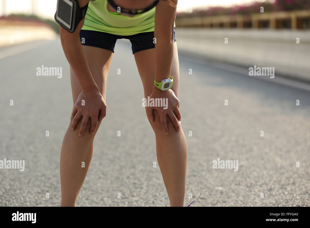 tired woman runner taking a rest after running hard on city road Stock ...