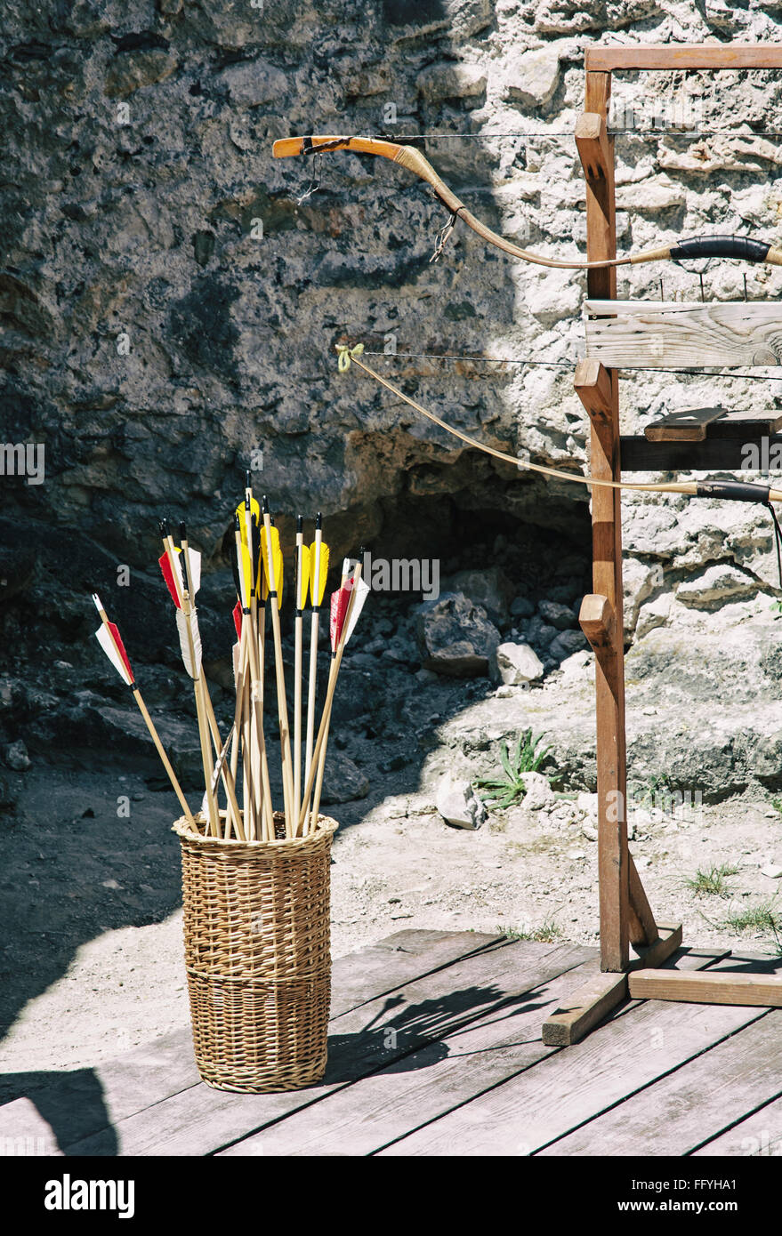 Vintage bow and arrows with ruins wall background. Outdoor activity ...