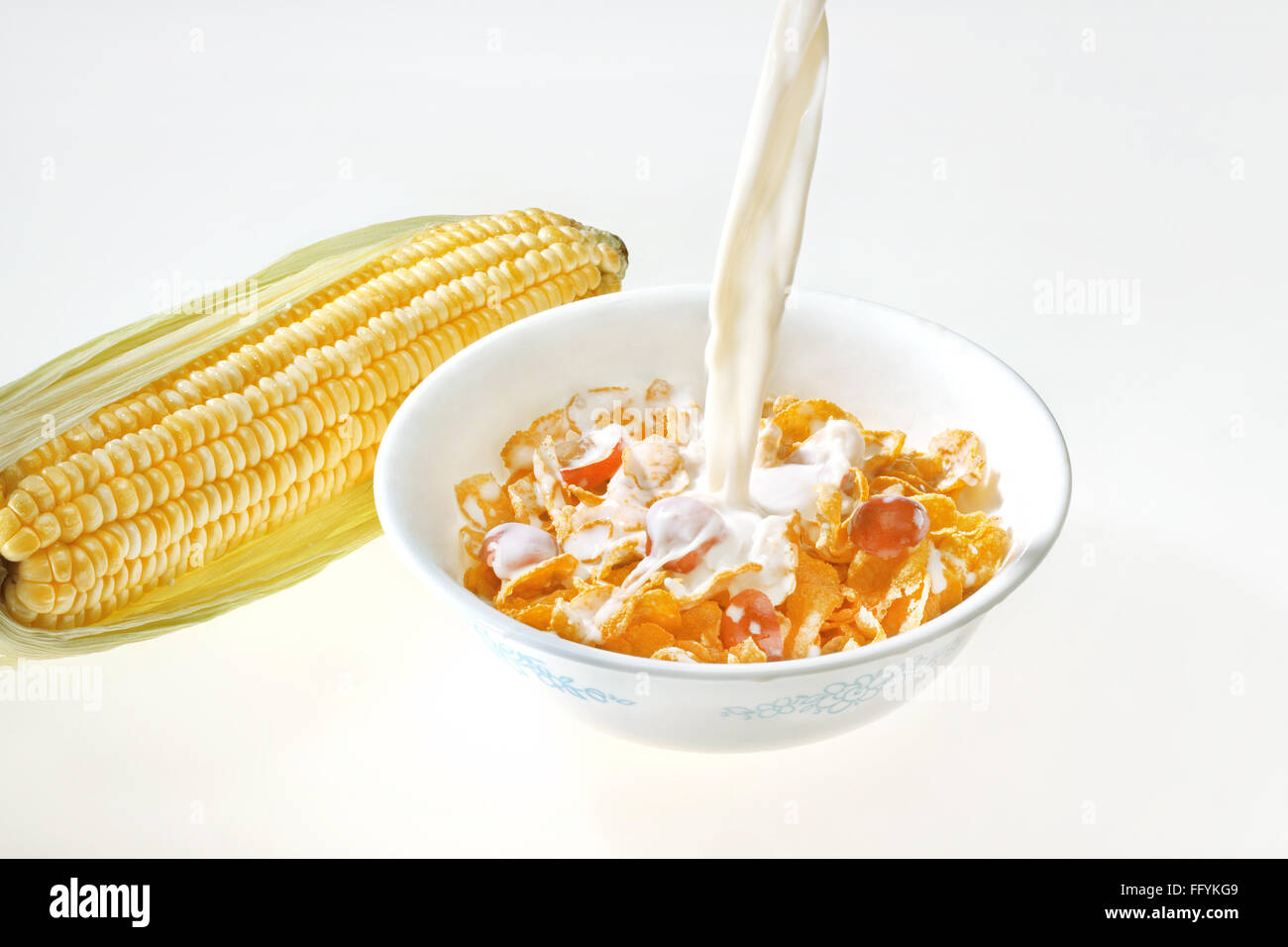 Milk pouring on sweet corn flakes in a bowl for breakfast India Stock ...