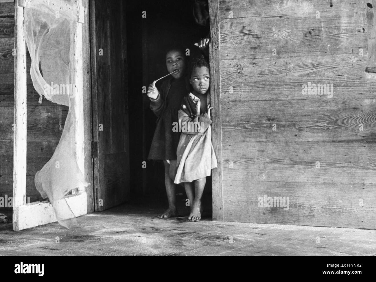 GEORGIA: POVERTY, 1966. /nTwo children peering out from the doorway of ...