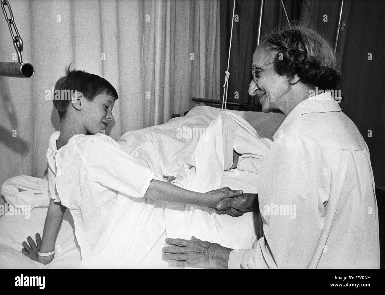 AMERICORPS VOLUNTEER, 1971. /nAn Americorps Foster Grandparent, Tobie Nachlas, visiting a young ...