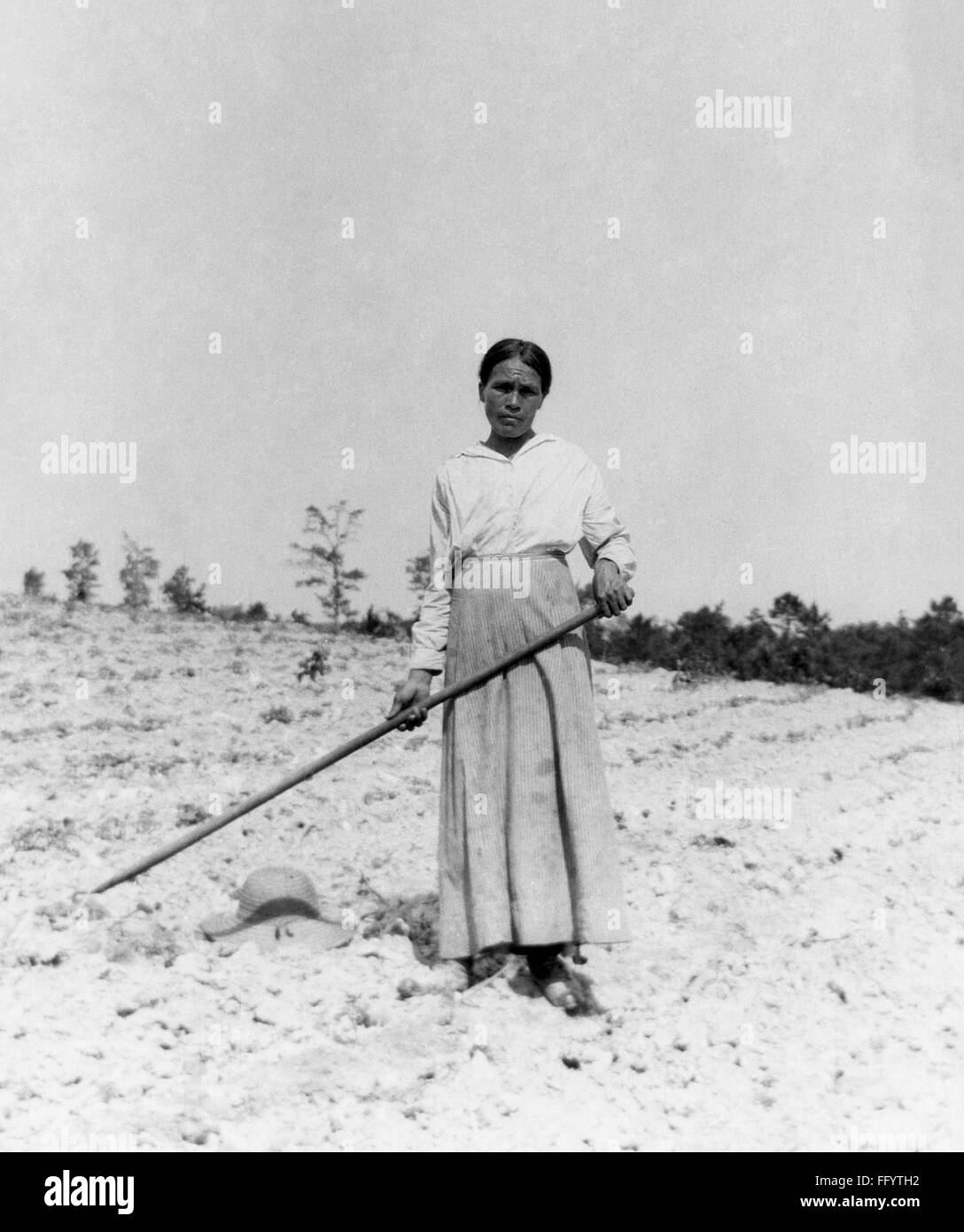 NATIVE AMERICAN FARMER. /nA Native American woman tilling the soil in a ...
