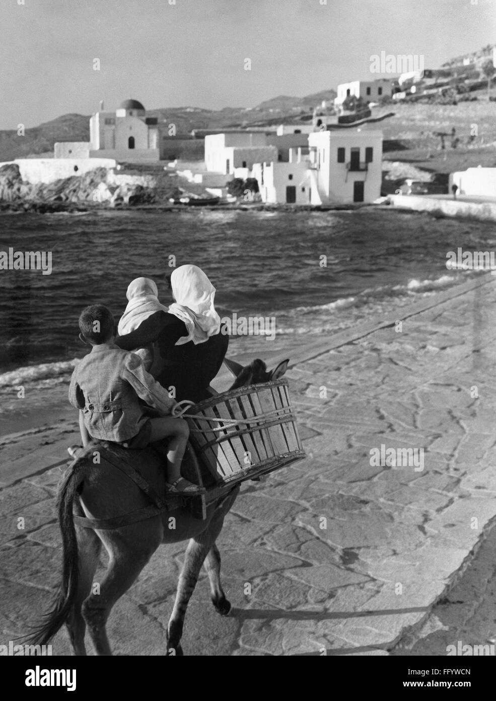 MYKONOS: PEASANT FAMILY. /nA peasant mother and two children carry ...