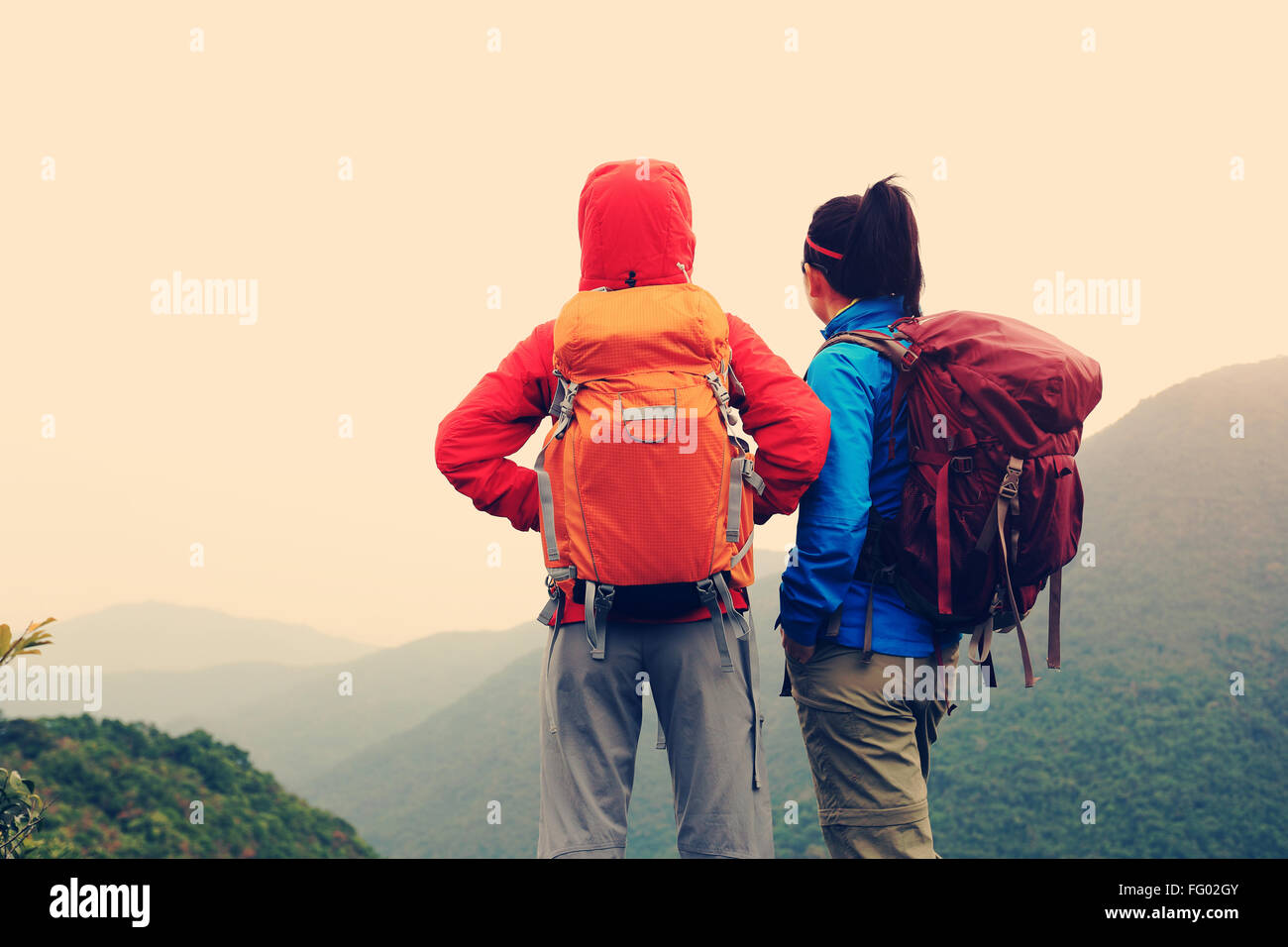 two successful backpacker enjoy the beautiful landscape at mountain ...