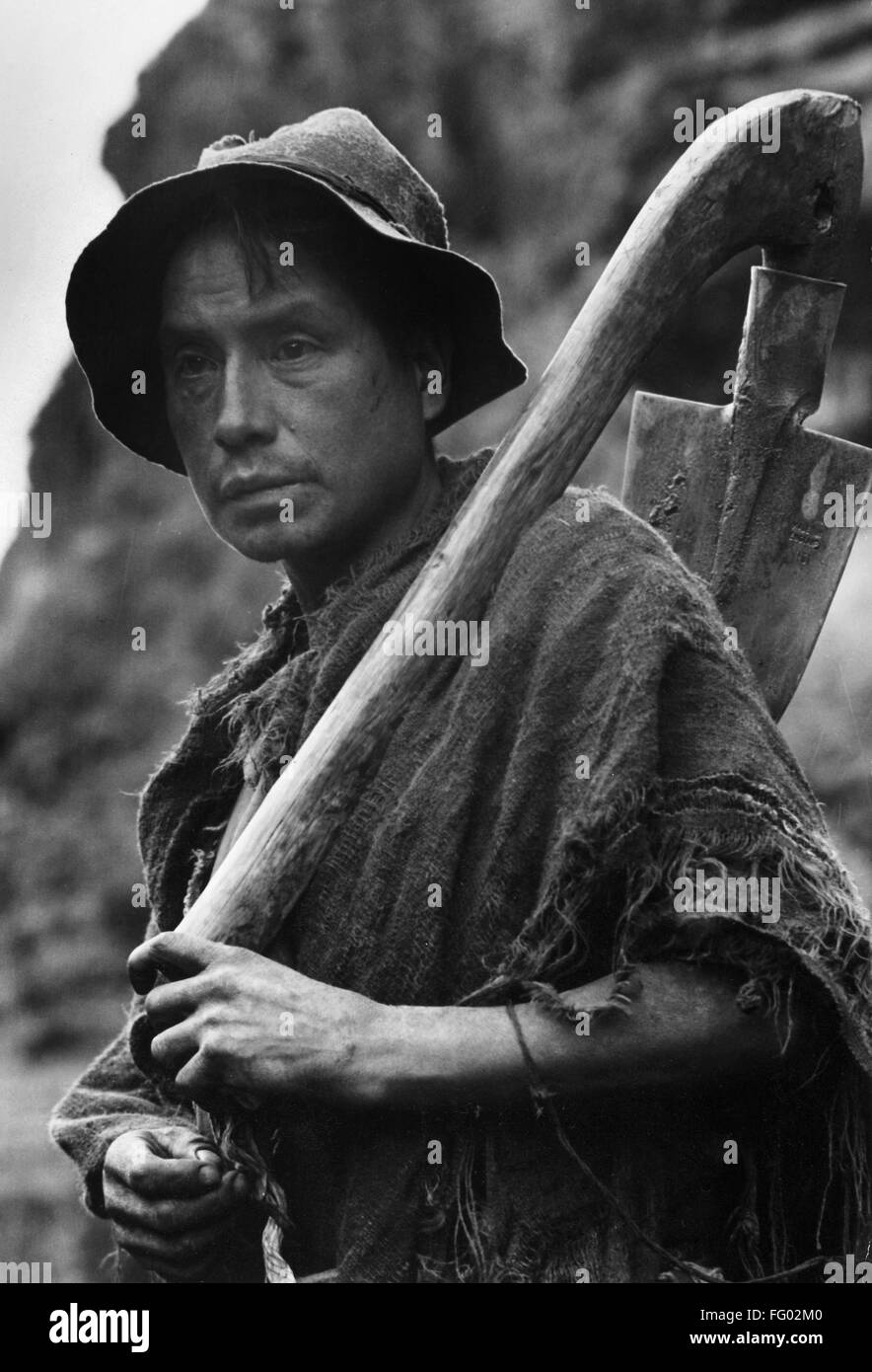 PERU: NATIVE MAN, c1965. /nA native Peruvian man holding a farm tool ...