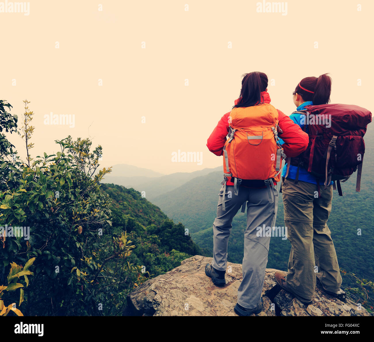 two successful backpacker enjoy the beautiful landscape at mountain ...