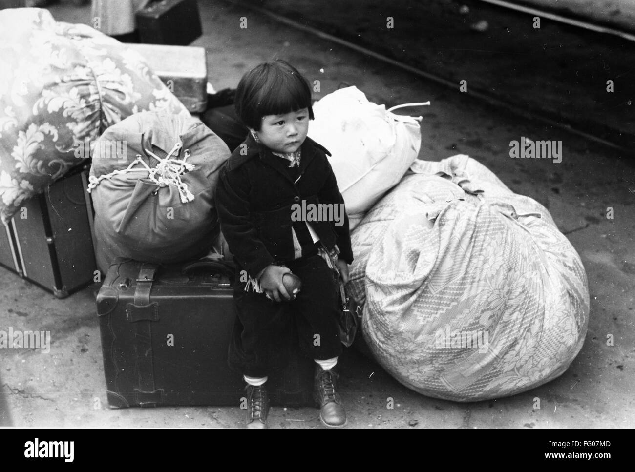 JAPANESE INTERNMENT, 1942. /nA Japanese American child at a train ...