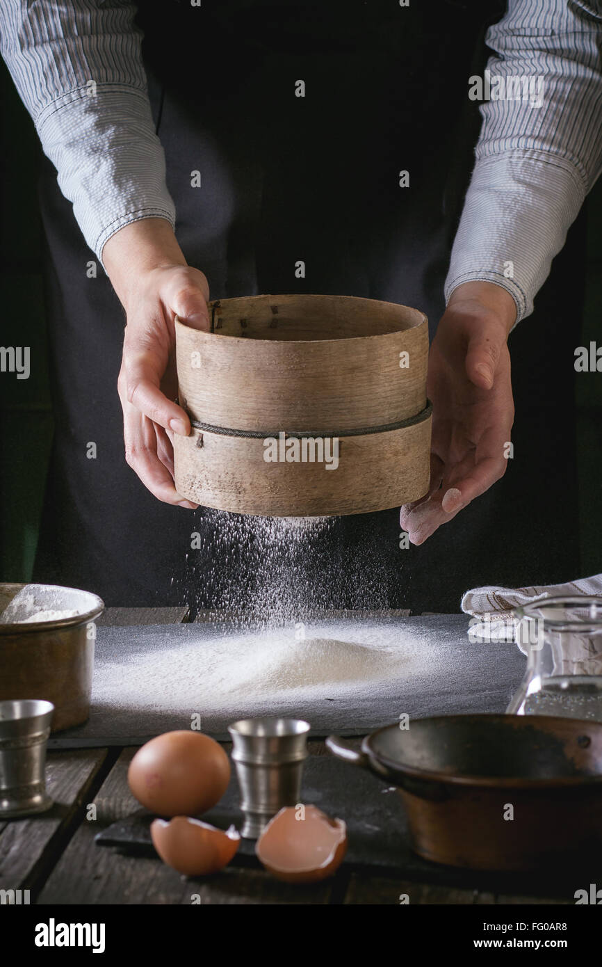 Sifting flour by female hands Stock Photo - Alamy