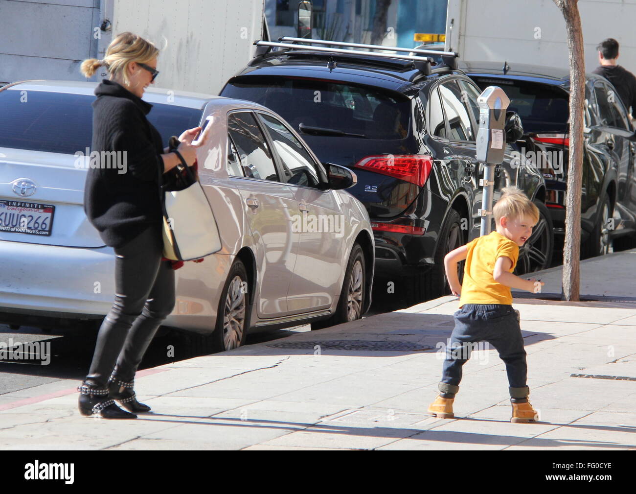 Hilary Duff takes pictures of her son, Luca, dancing on the sidewalk ...