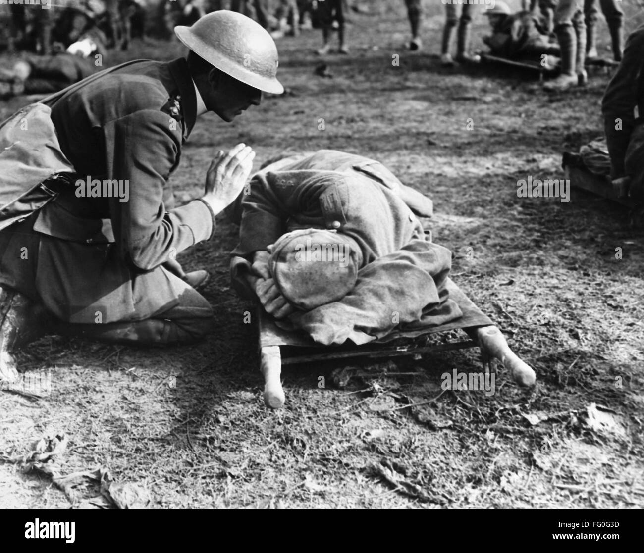 WORLD WAR I: PRIEST. /nA British priest saying a prayer over a dying ...