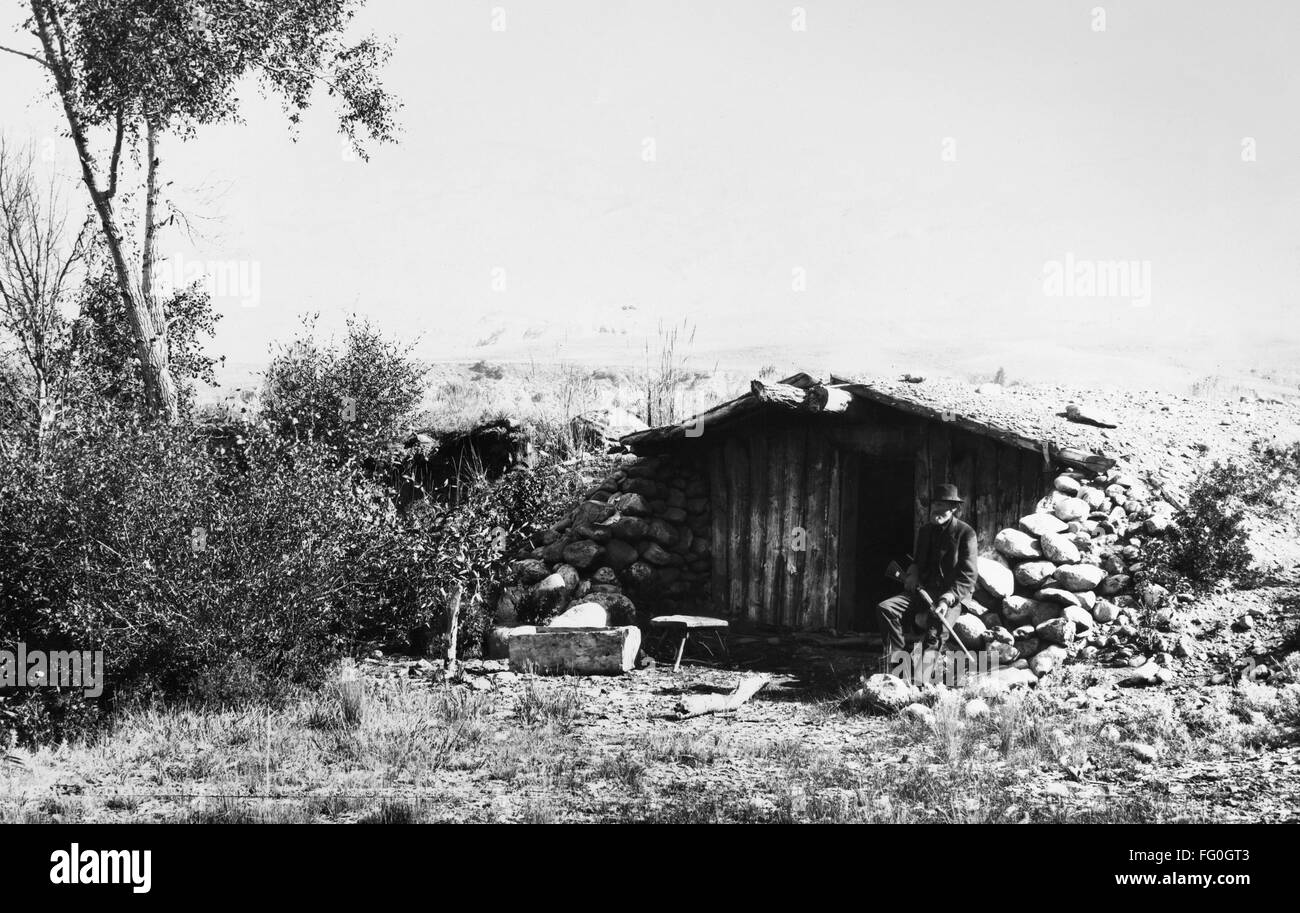COLORADO: DUGOUT HOME. /nA frontiersman seated outside his dugout cabin ...