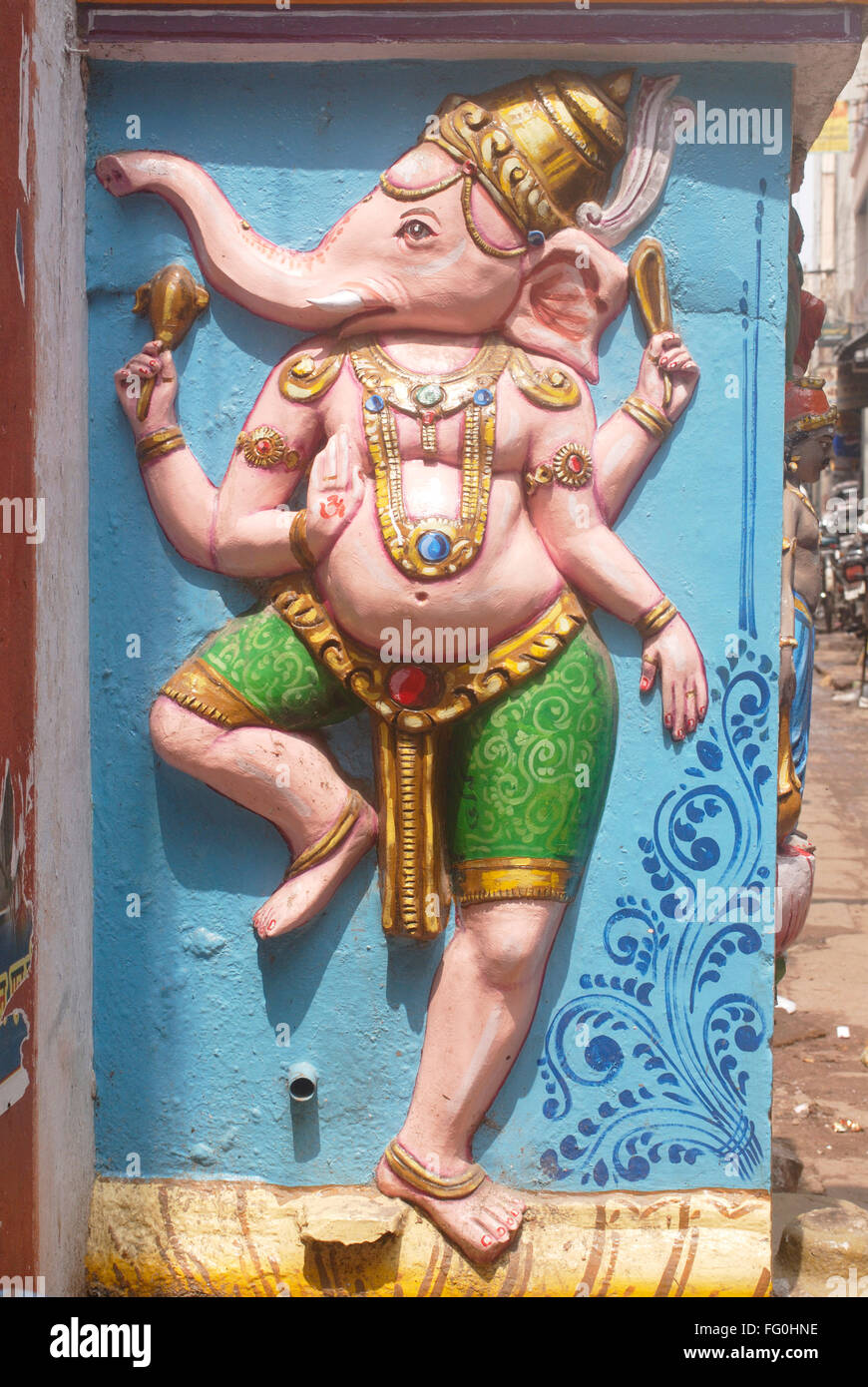 Colourfully painted relief of dancing lord Ganesh Ganpati on wall of ...