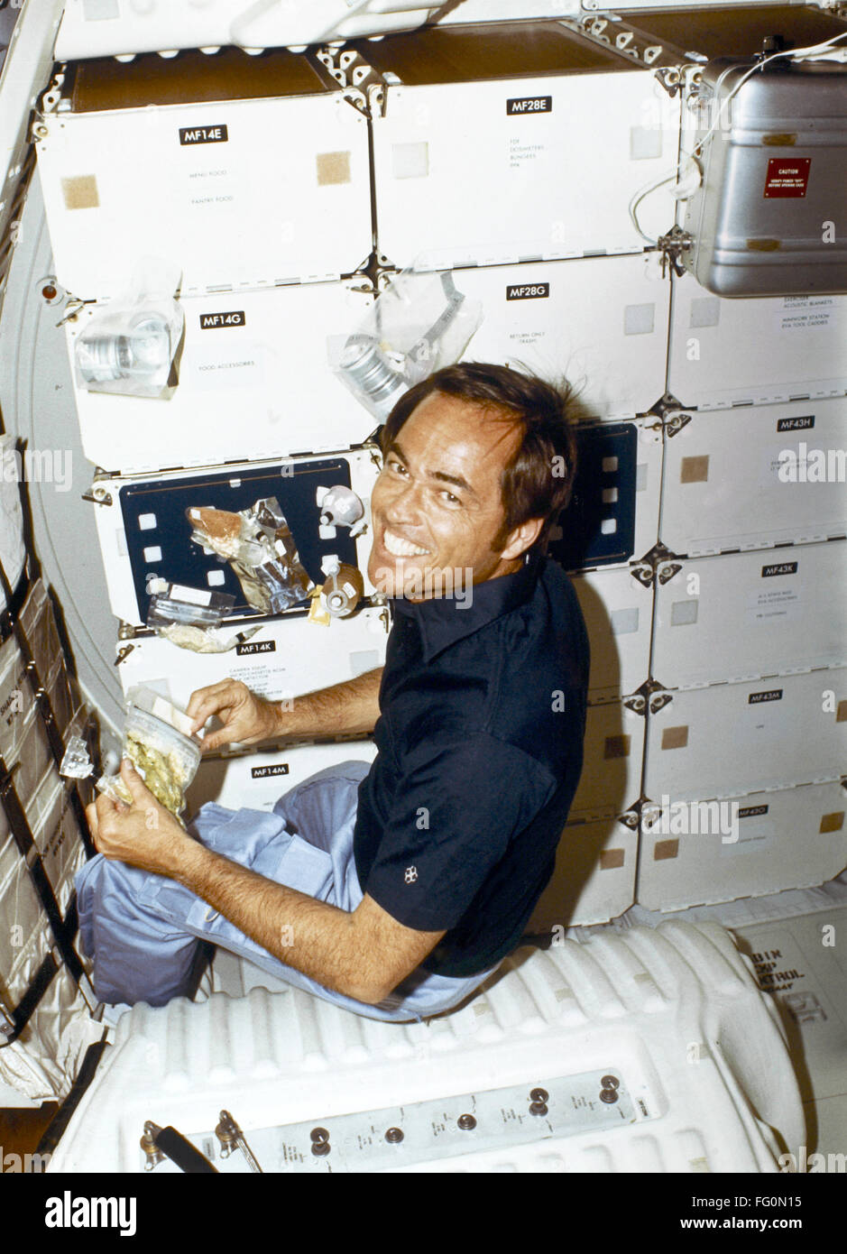 ROBERT CRIPPEN (1937- ). /nAmerican astronaut. Preparing a meal in the ...
