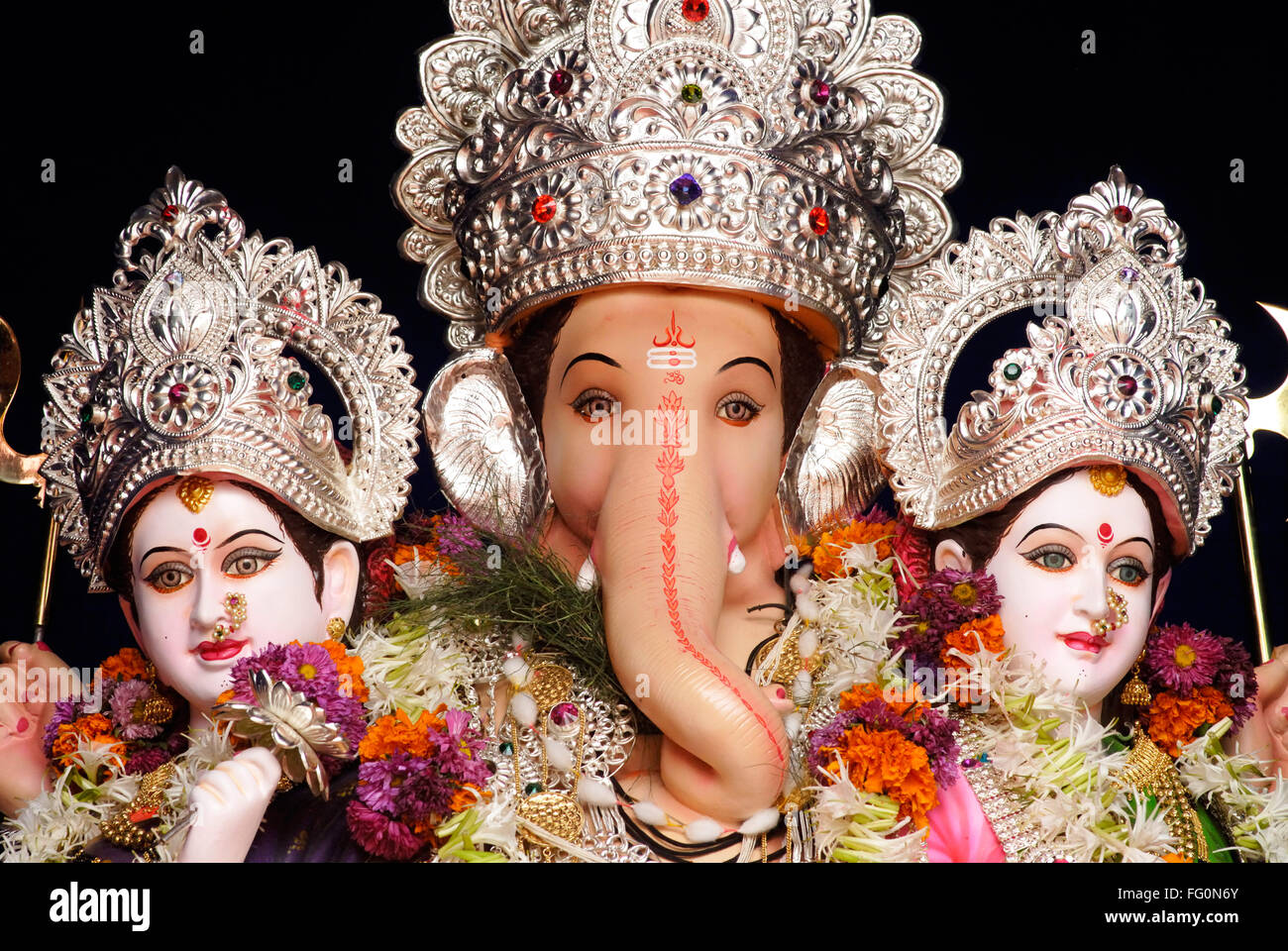 Richly decorated idol lord ganesh elephant headed god sitting consorts ...