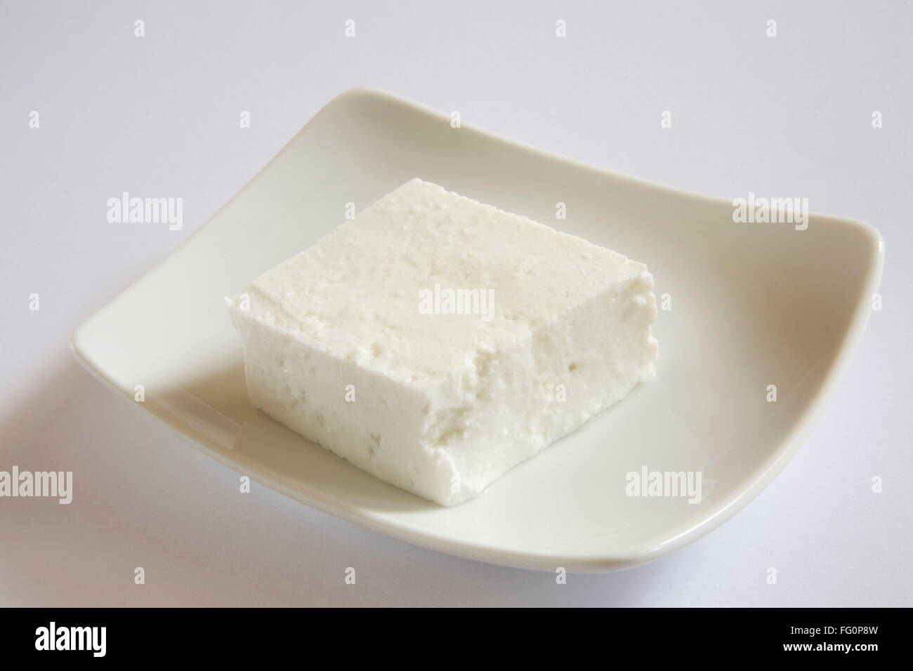 Cottage paneer pressed into firm or soft mass home or dairy product ...