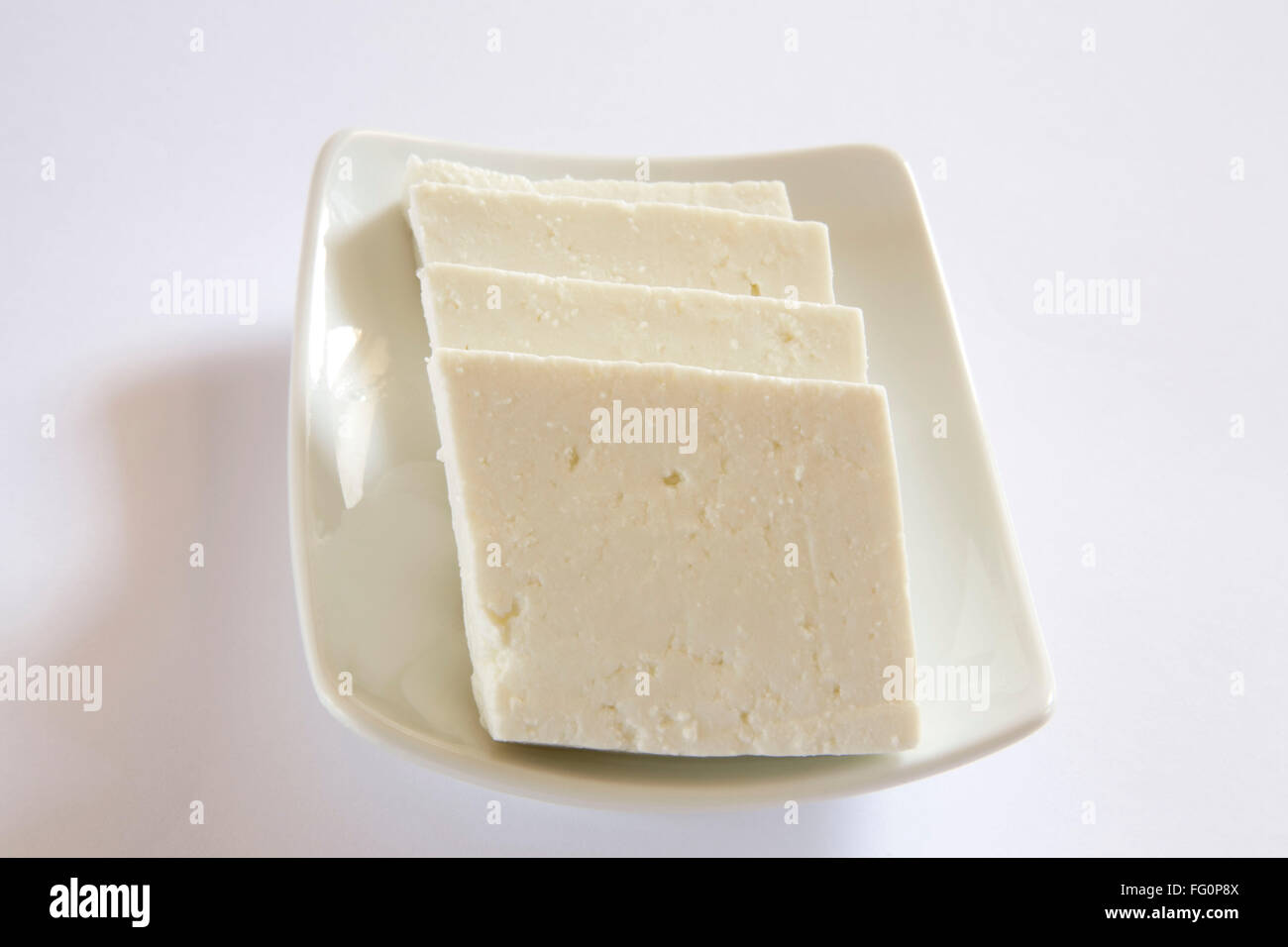 Cottage paneer pressed into firm or soft mass home or dairy product ...