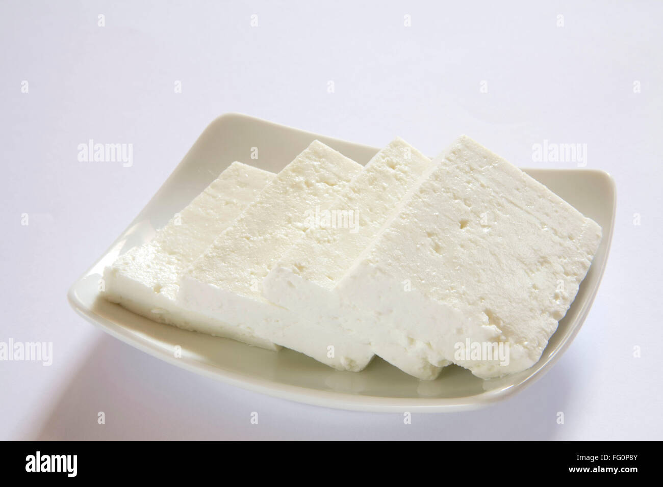 Cottage paneer pressed into firm or soft mass home or dairy product ...