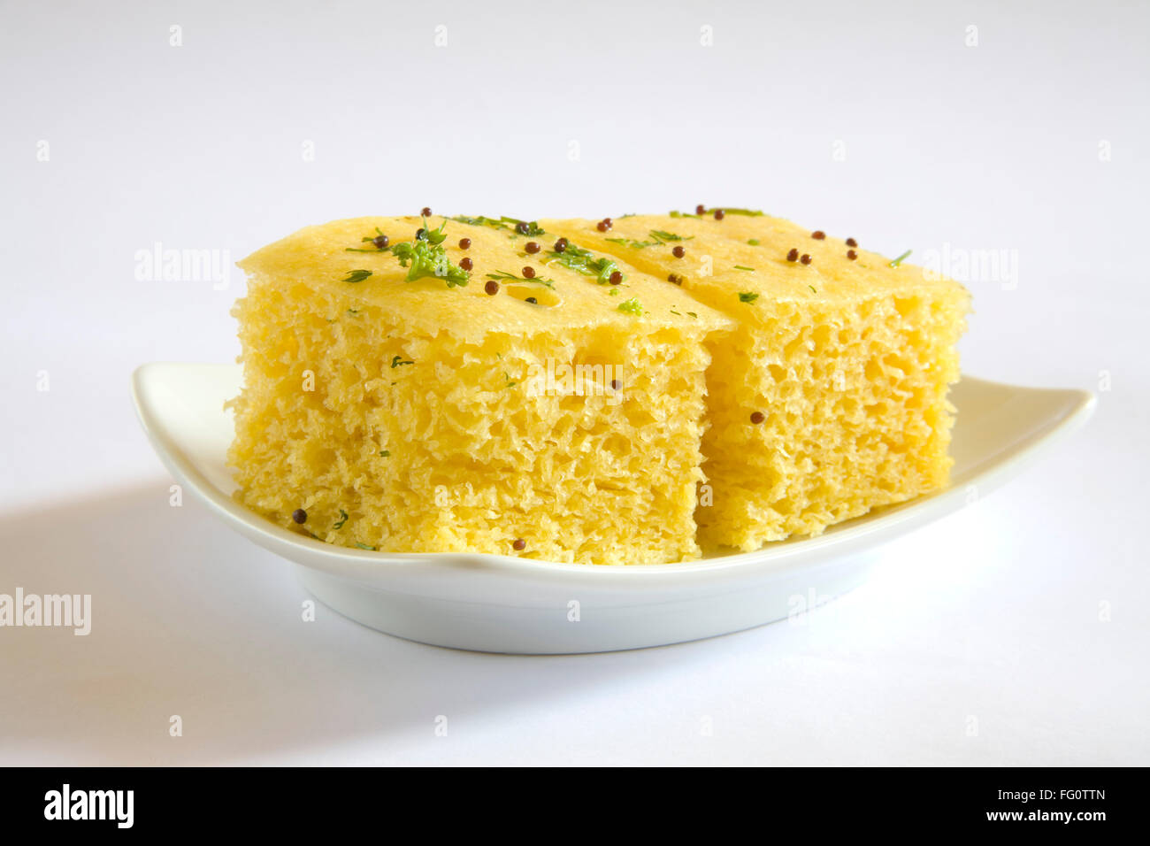 Indian cuisine , fast food Dhokla served in dish on white background ...