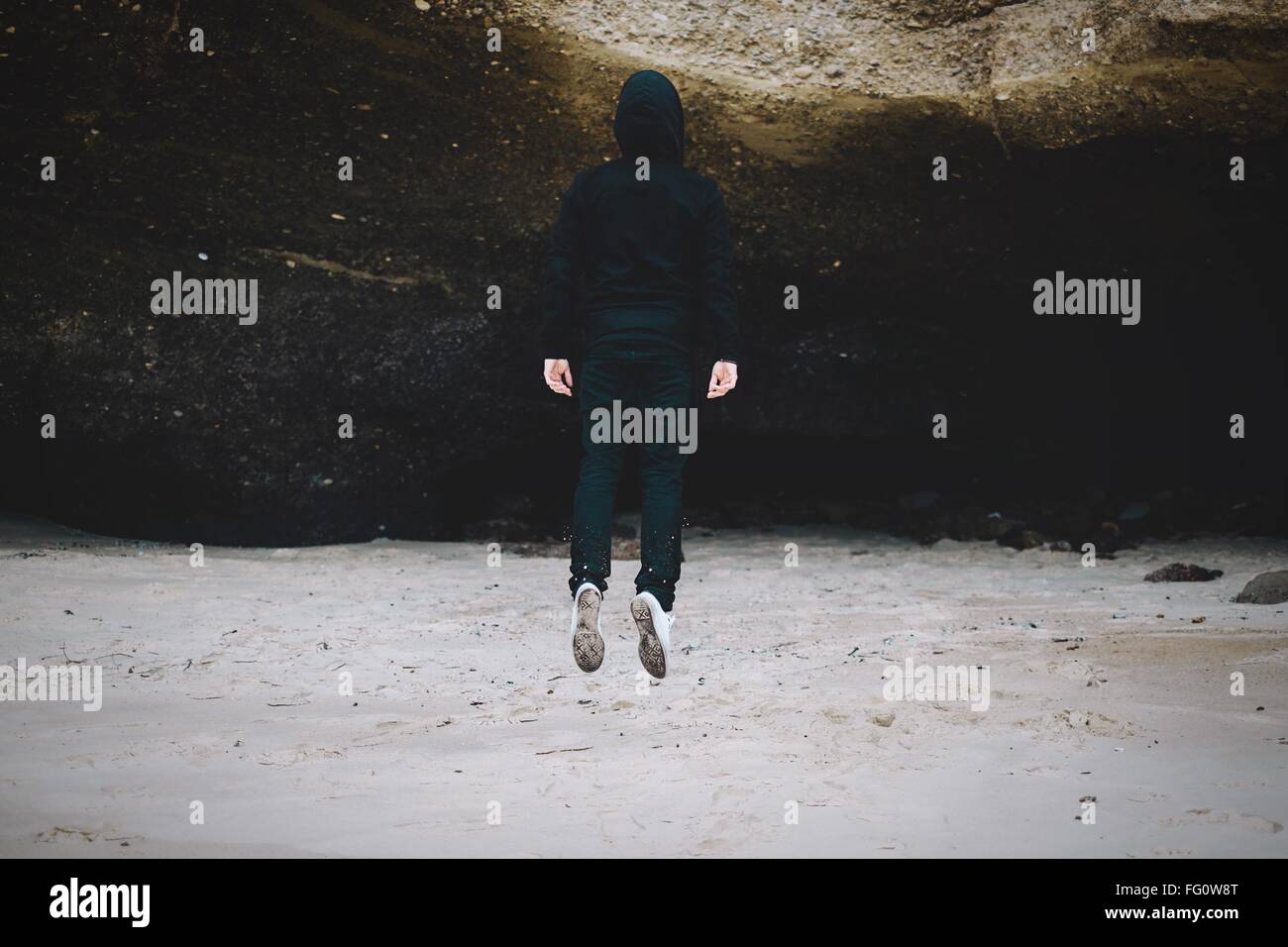 Rear View Of A Woman Jumping On Landscape Stock Photo - Alamy
