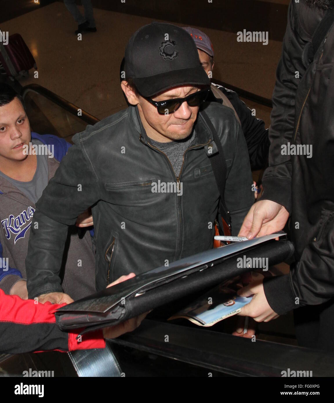 Jeremy Renner signs autographs for fans as he departs from Los Angeles ...