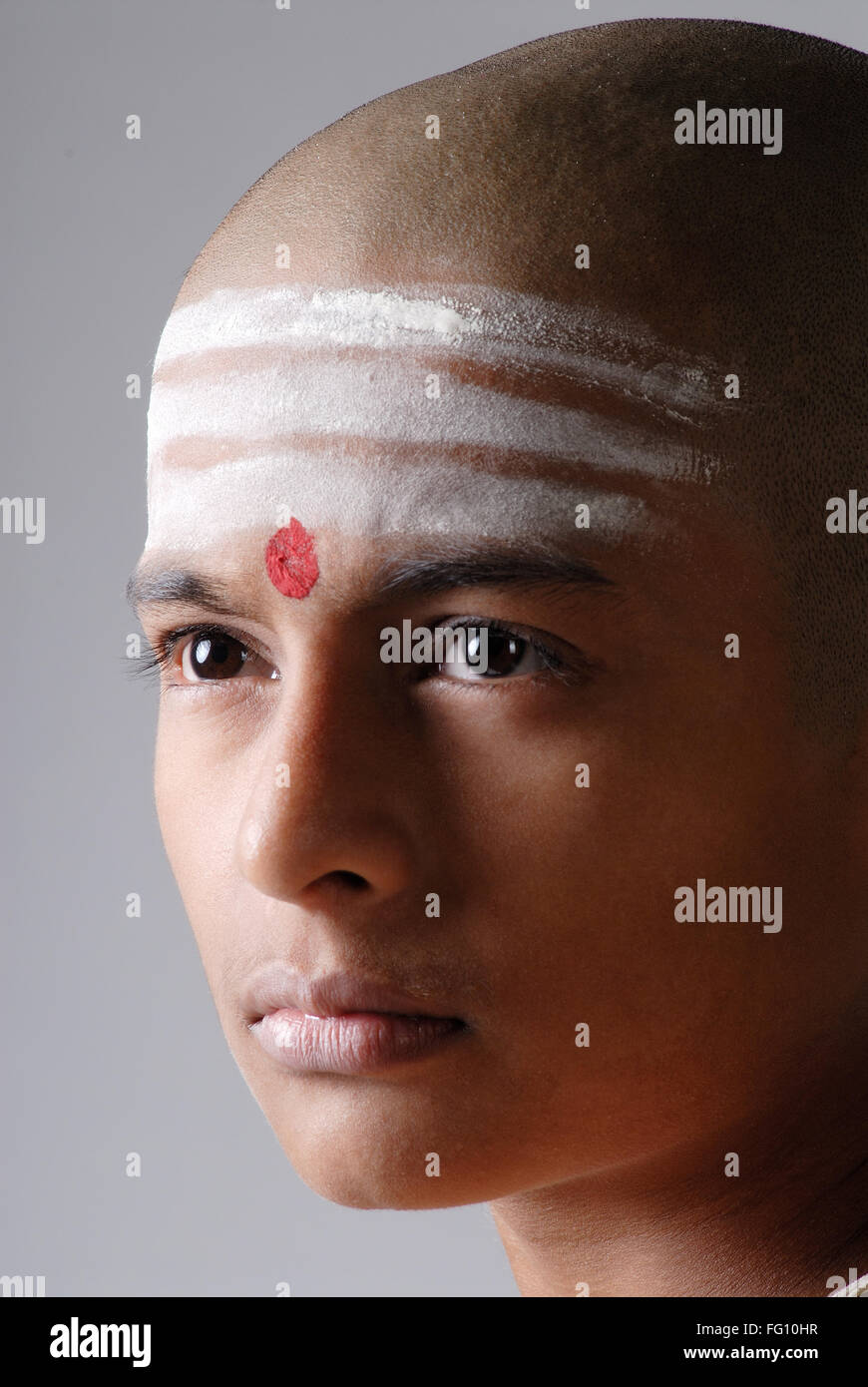 Indian Hindu bald boy with red tilak white shaivite symbol on forehead ...