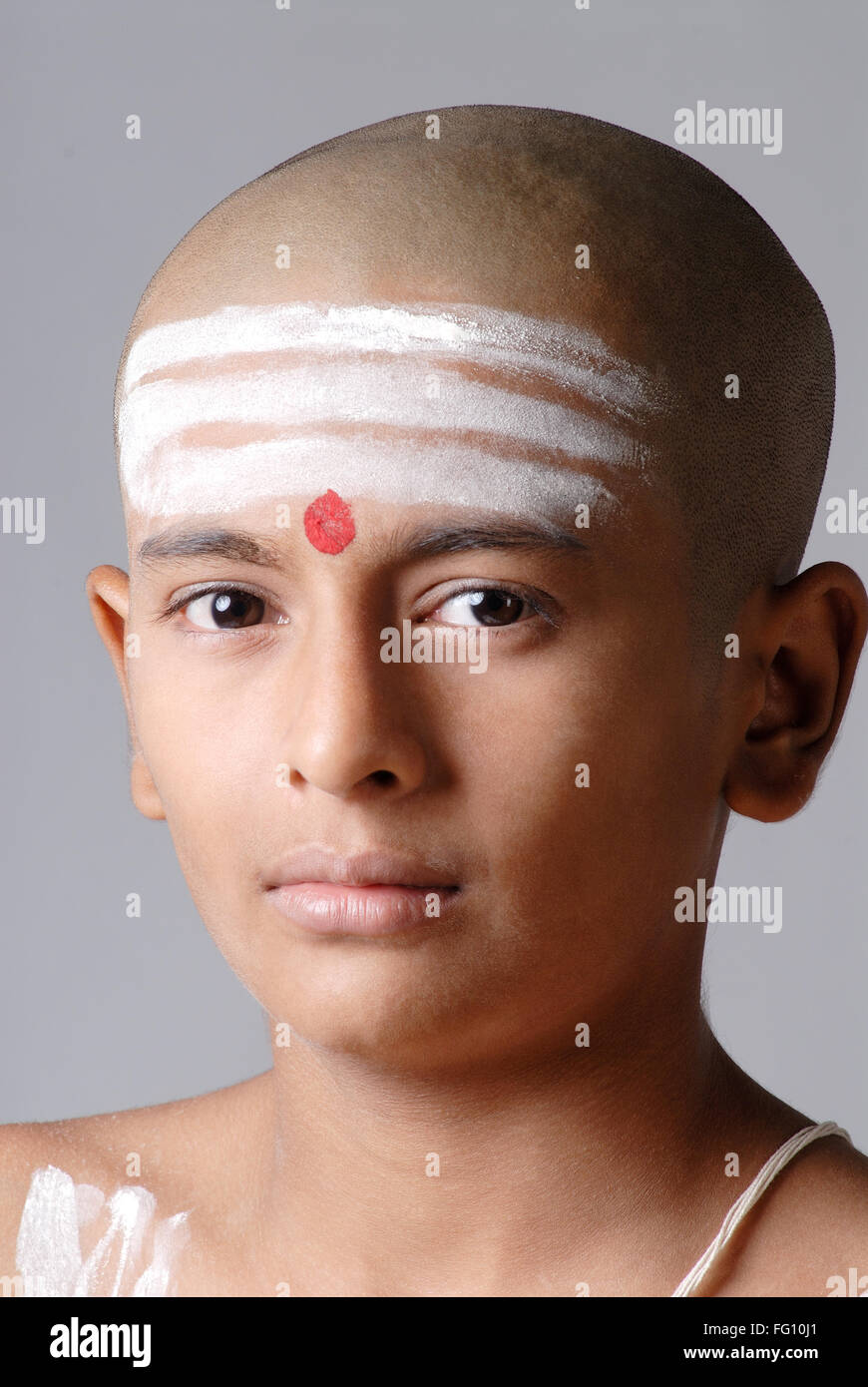 Indian Hindu bald boy with red tilak white shaivite symbol on forehead ...