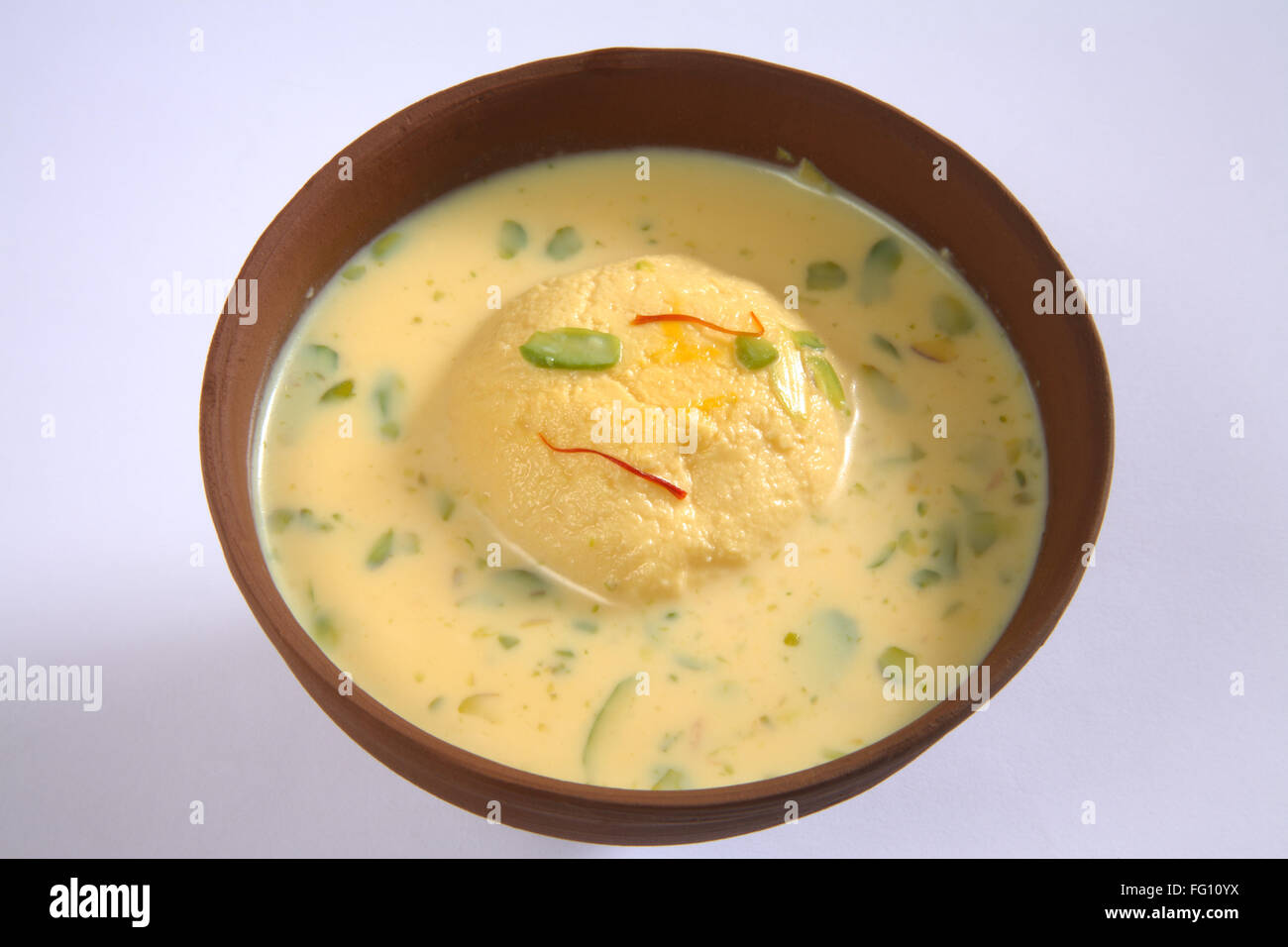 Indian sweet , kesar rasmalai garnish with pistachio and saffron served ...