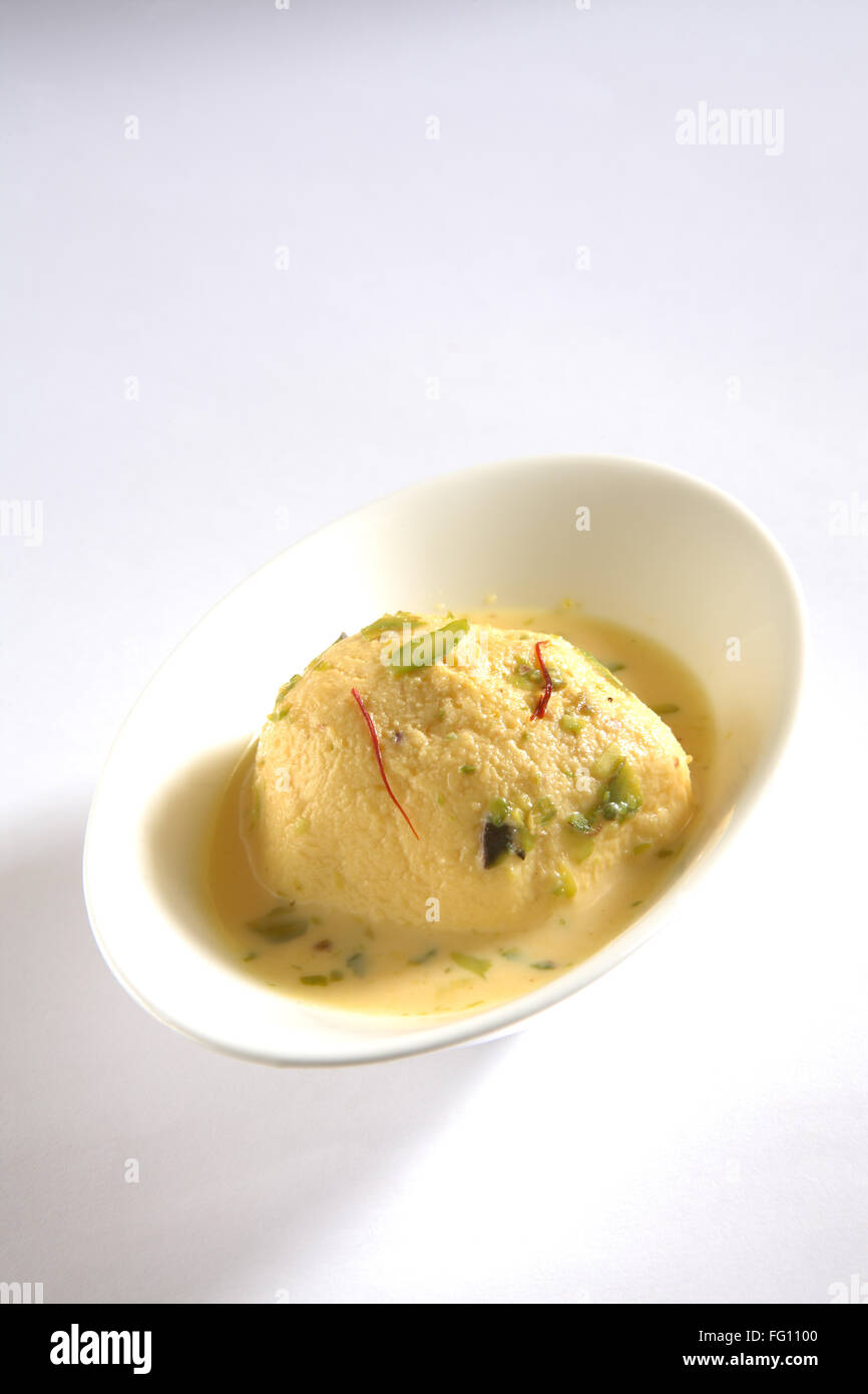 Indian sweet , kesar rasmalai garnish with pistachio and saffron served ...