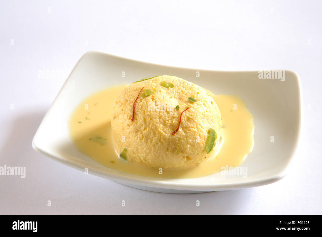 Indian sweet , kesar rasmalai garnish with pistachio and saffron served ...