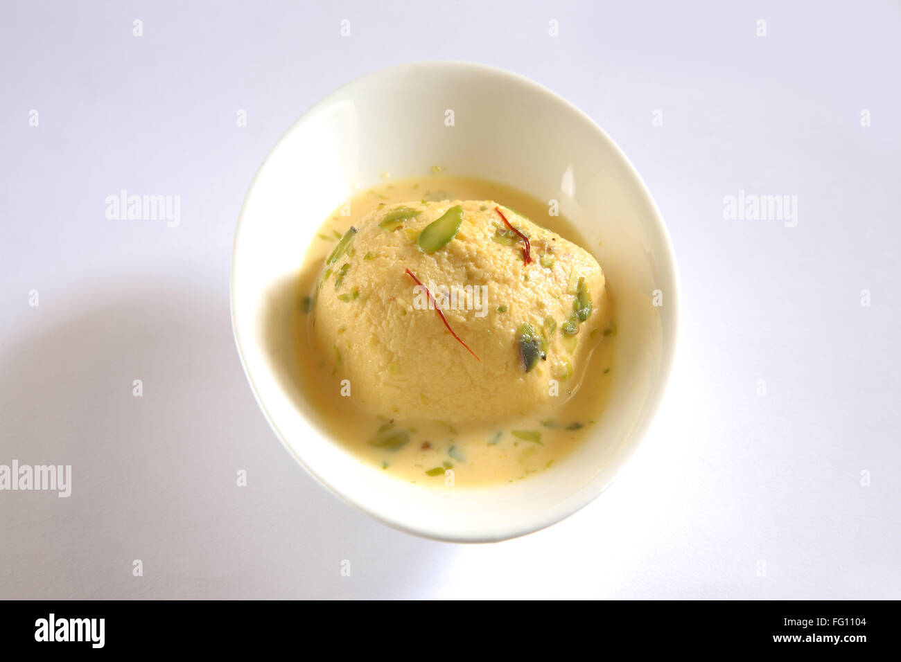 Indian sweet , kesar rasmalai garnish with pistachio and saffron served ...
