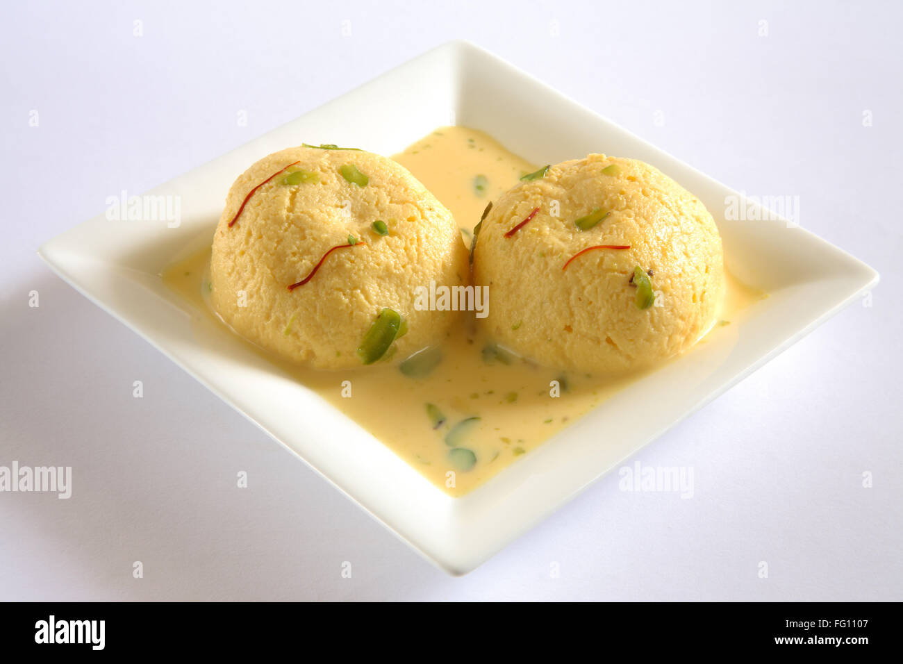 Indian sweet , kesar rasmalai garnish with pistachio and saffron served ...