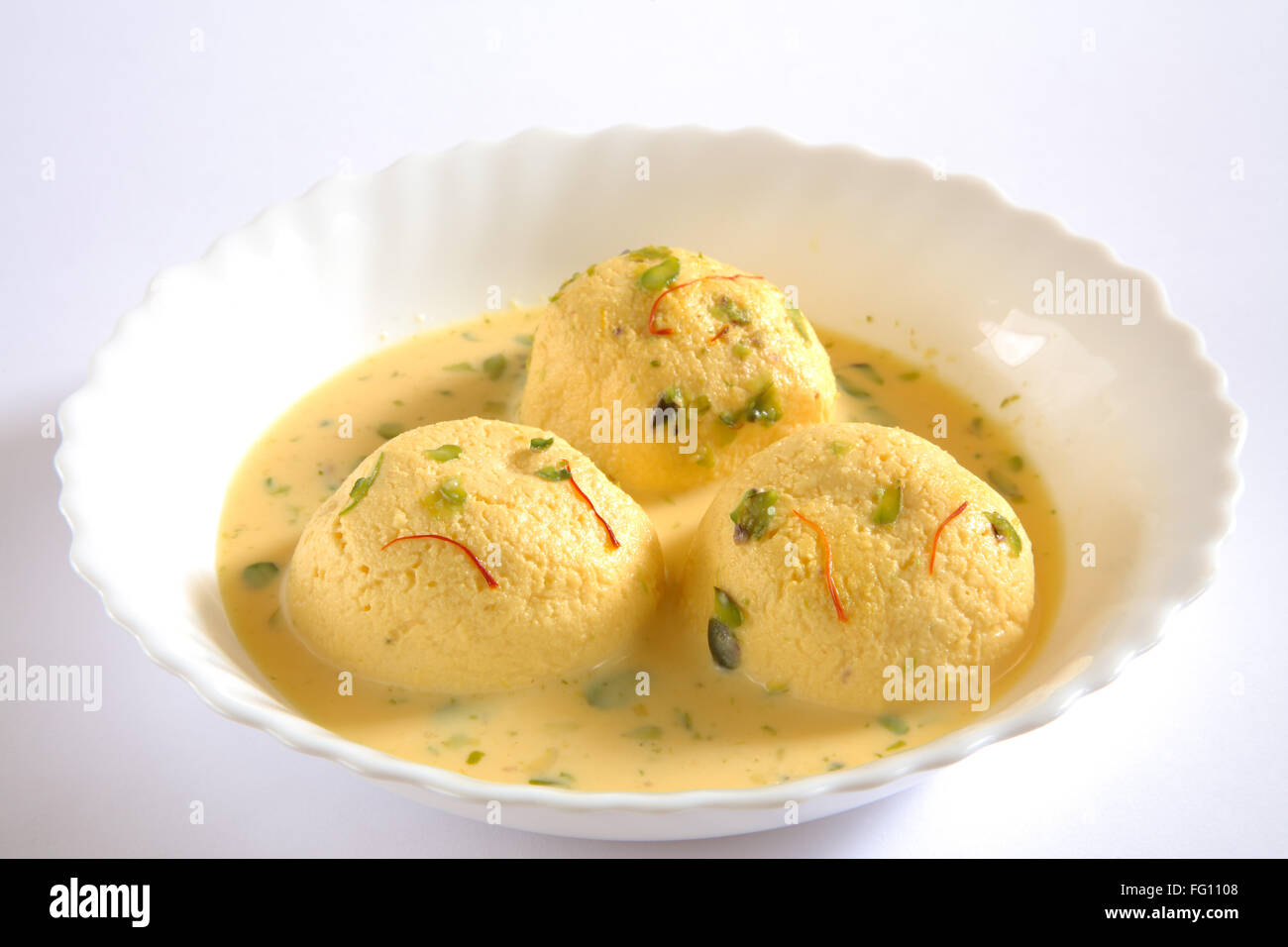 Indian sweet kesar rasmalai garnish with pistachio and saffron served ...