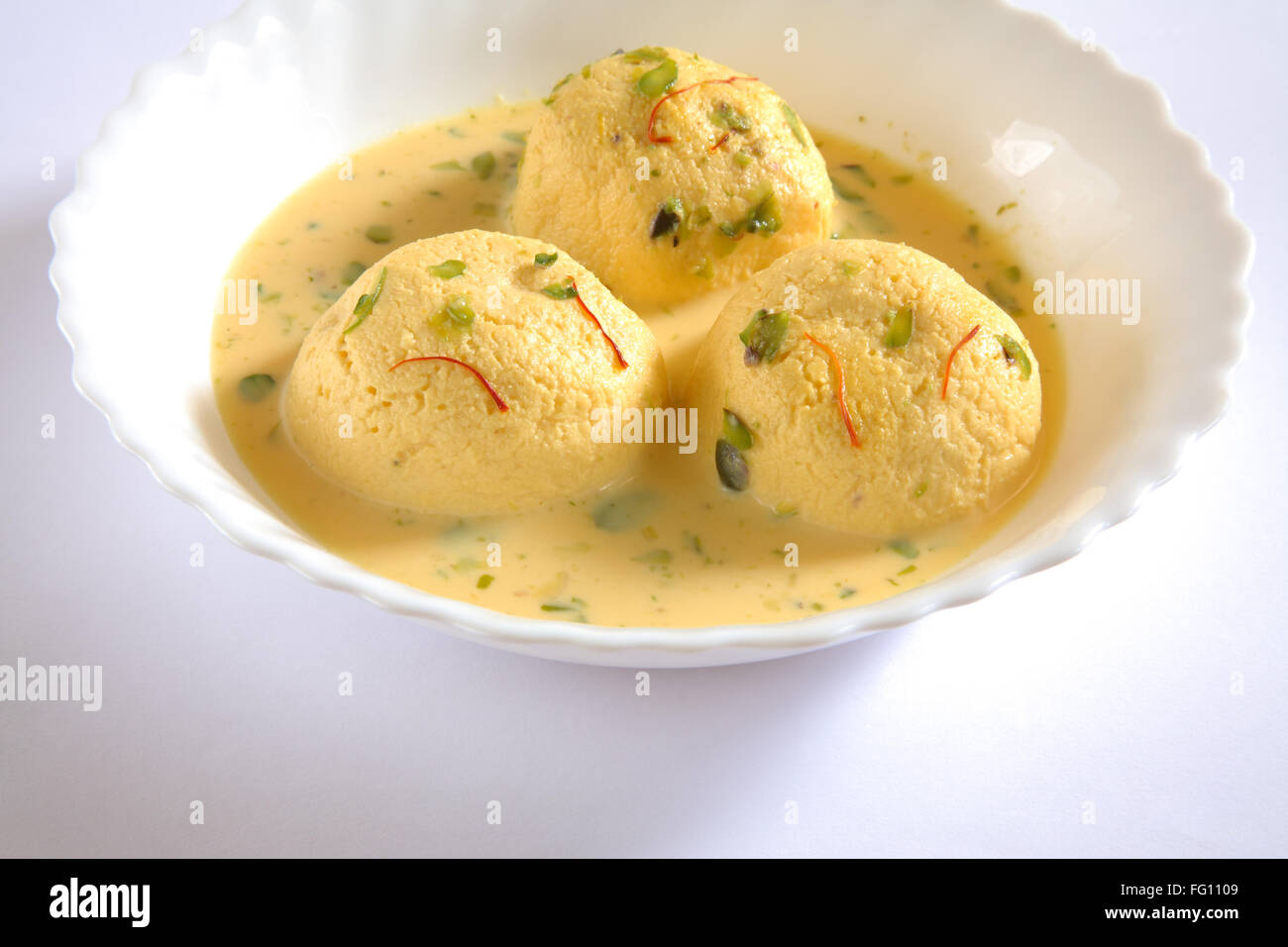 Indian sweet , kesar rasmalai garnish with pistachio and saffron served ...