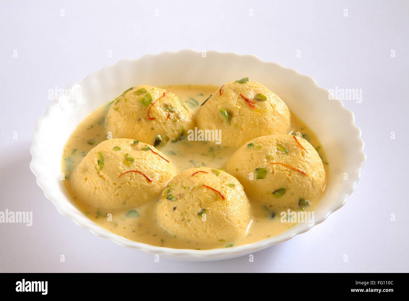 Indian sweet , kesar rasmalai garnish with pistachio and saffron served ...