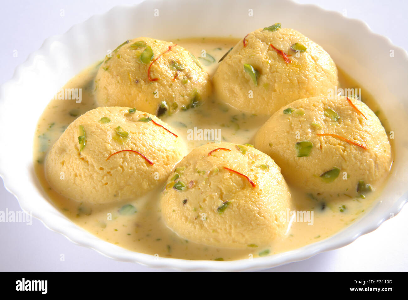 Indian sweet , kesar rasmalai garnish with pistachio and saffron served ...
