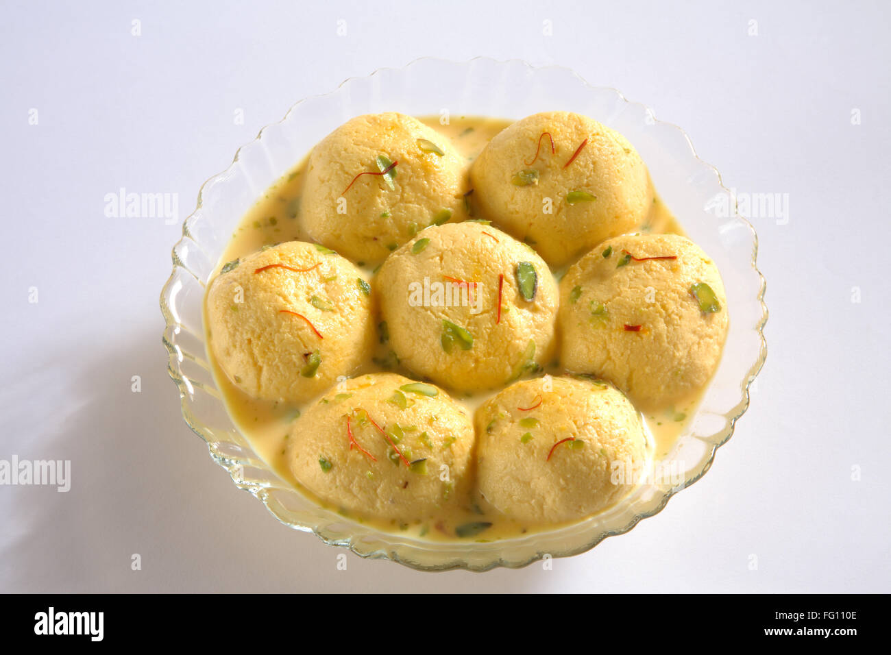 Indian sweet , kesar rasmalai garnish with pistachio and saffron served ...
