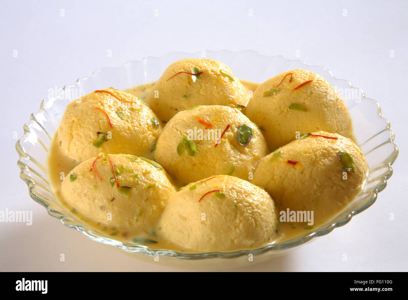 Indian sweet , kesar rasmalai garnish with pistachio and saffron served ...