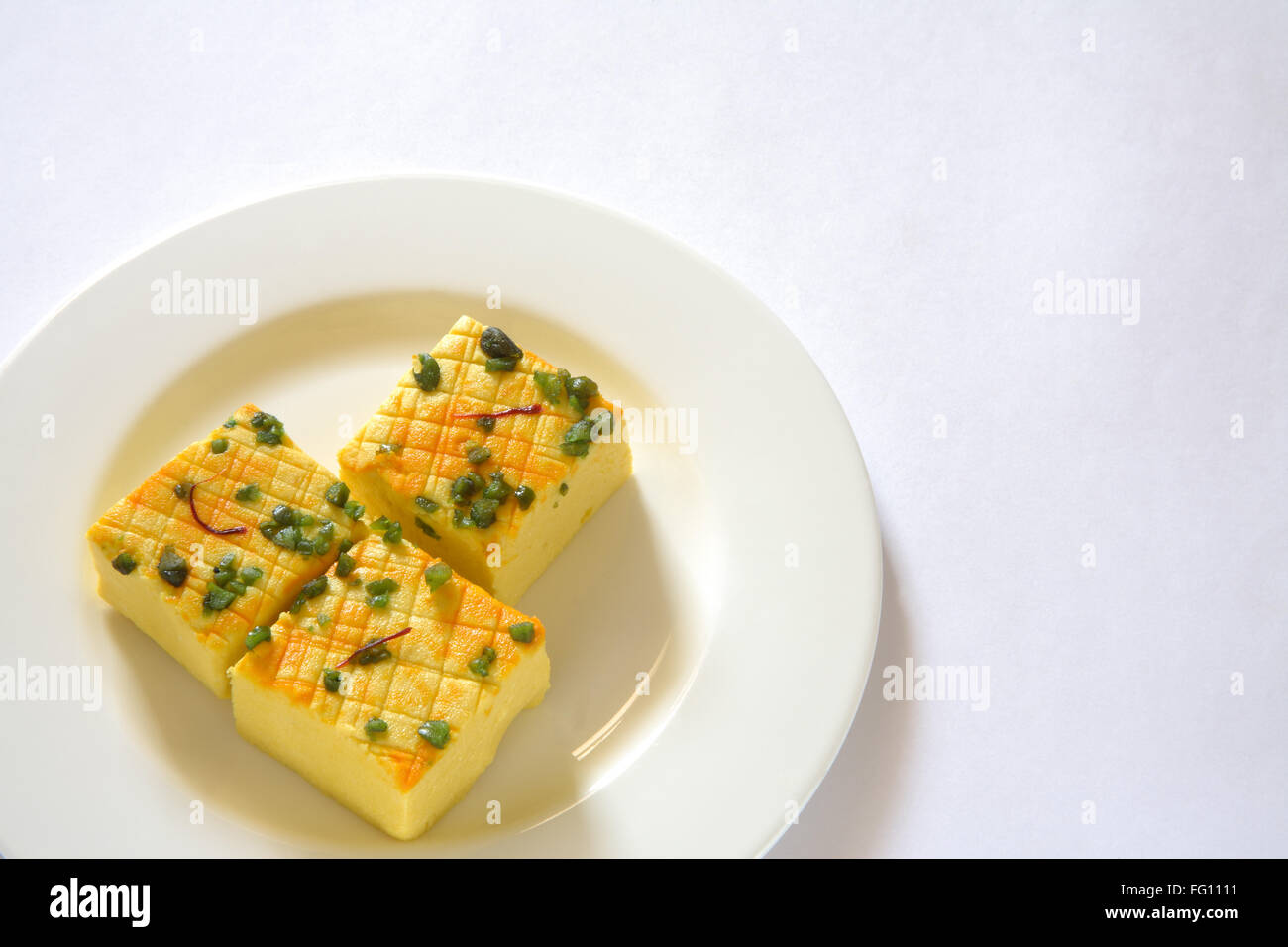 Indian sweet , sandesh bengali mithai garnish with pistachio and ...