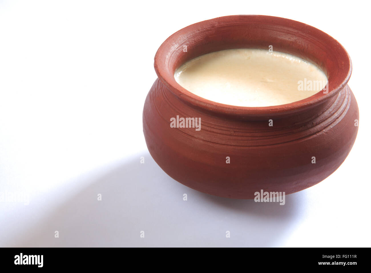 Indian sweet , mishti doi bengali mithai in earthen pot on white ...