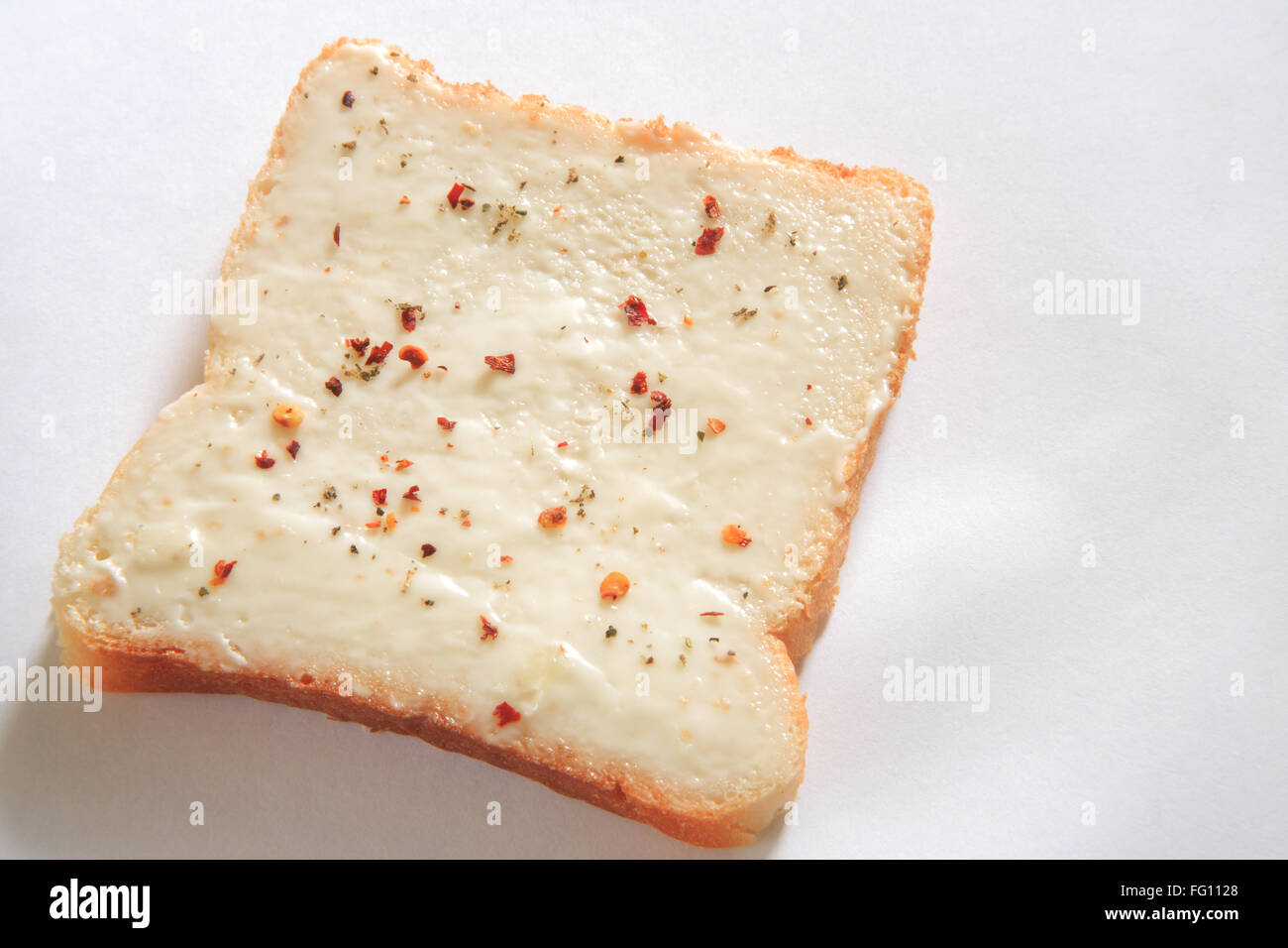 Breakfast food , bread cheese spread garnish with chilly powder on ...