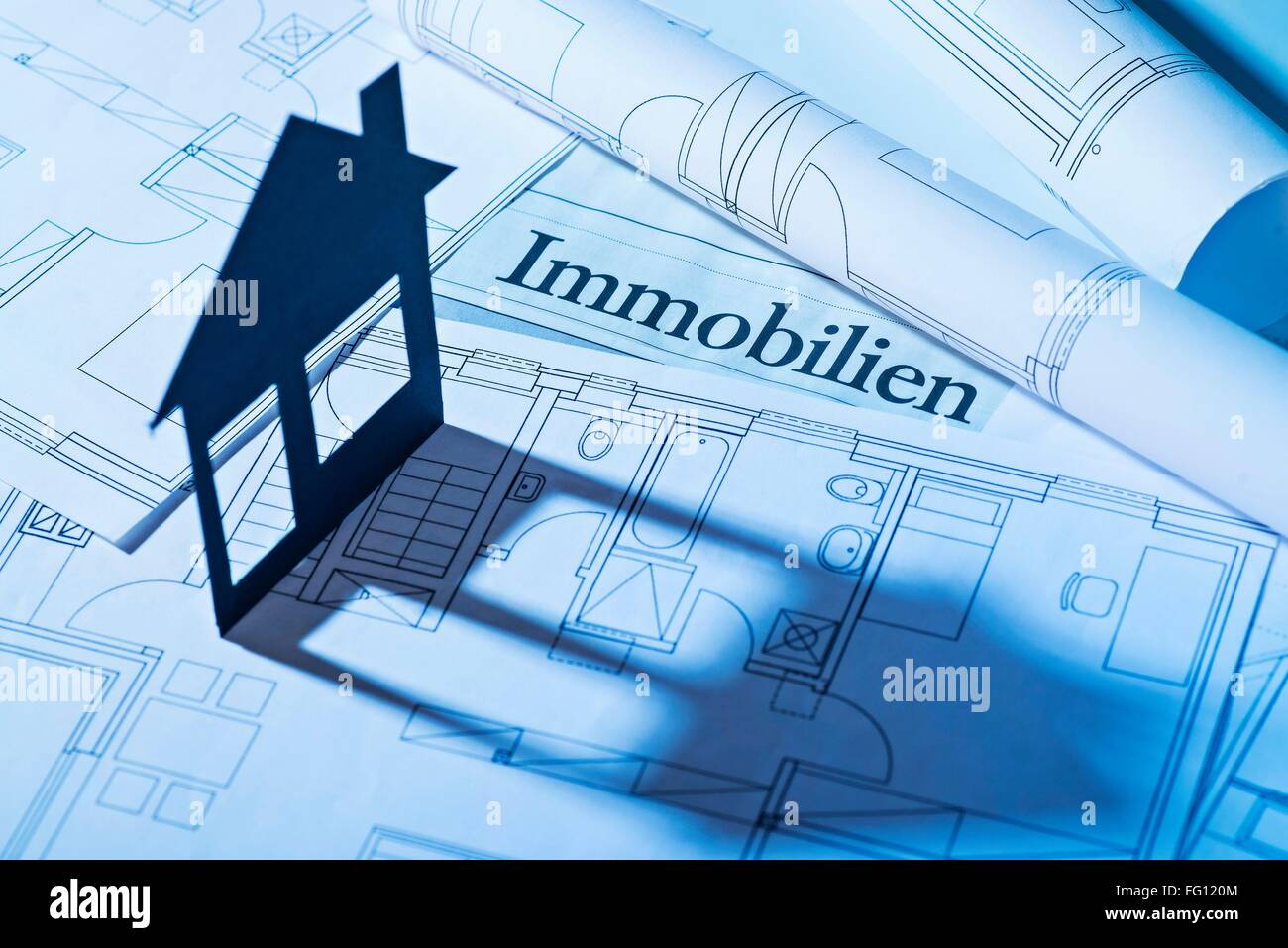 House casts a shadow on blueprints and the lettering Real estate Stock ...