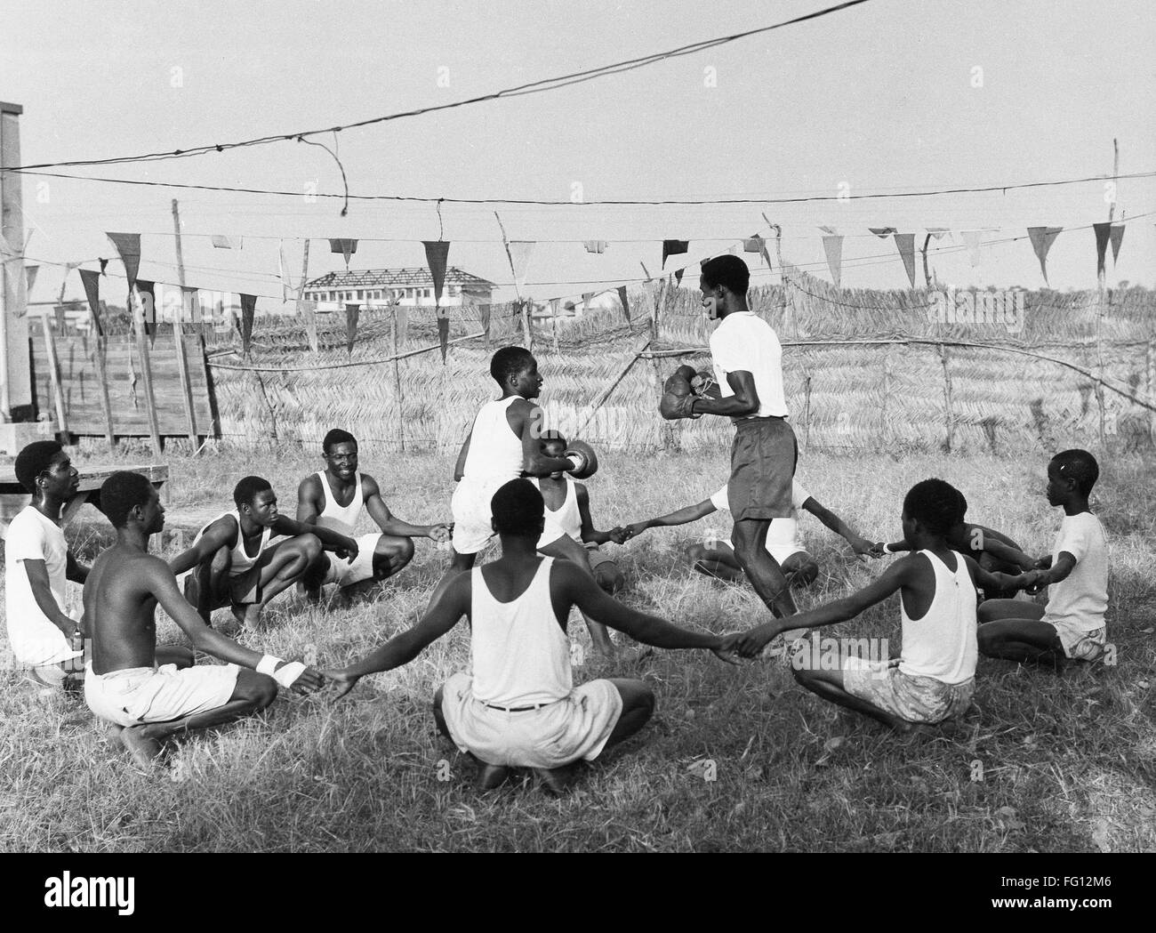 NIGERIA: BOXING. /nA group of young men form a ring around two boxers ...