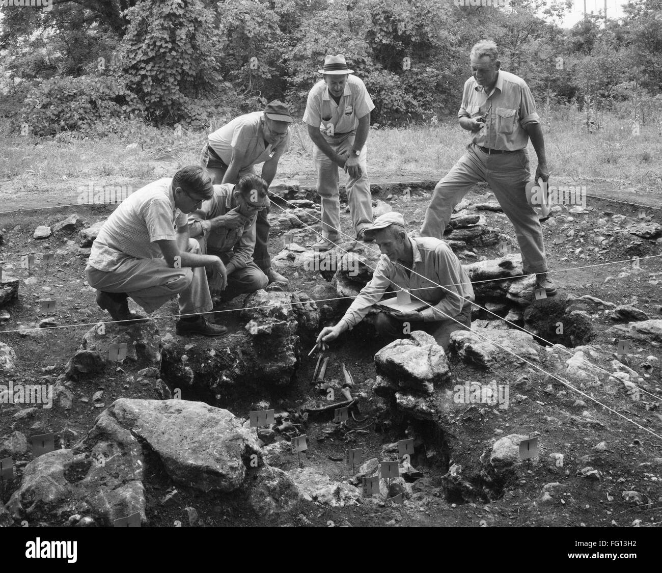 ARCHAEOLOGY: BURIAL SITE. /nArchaeologists at an excavated burial site ...