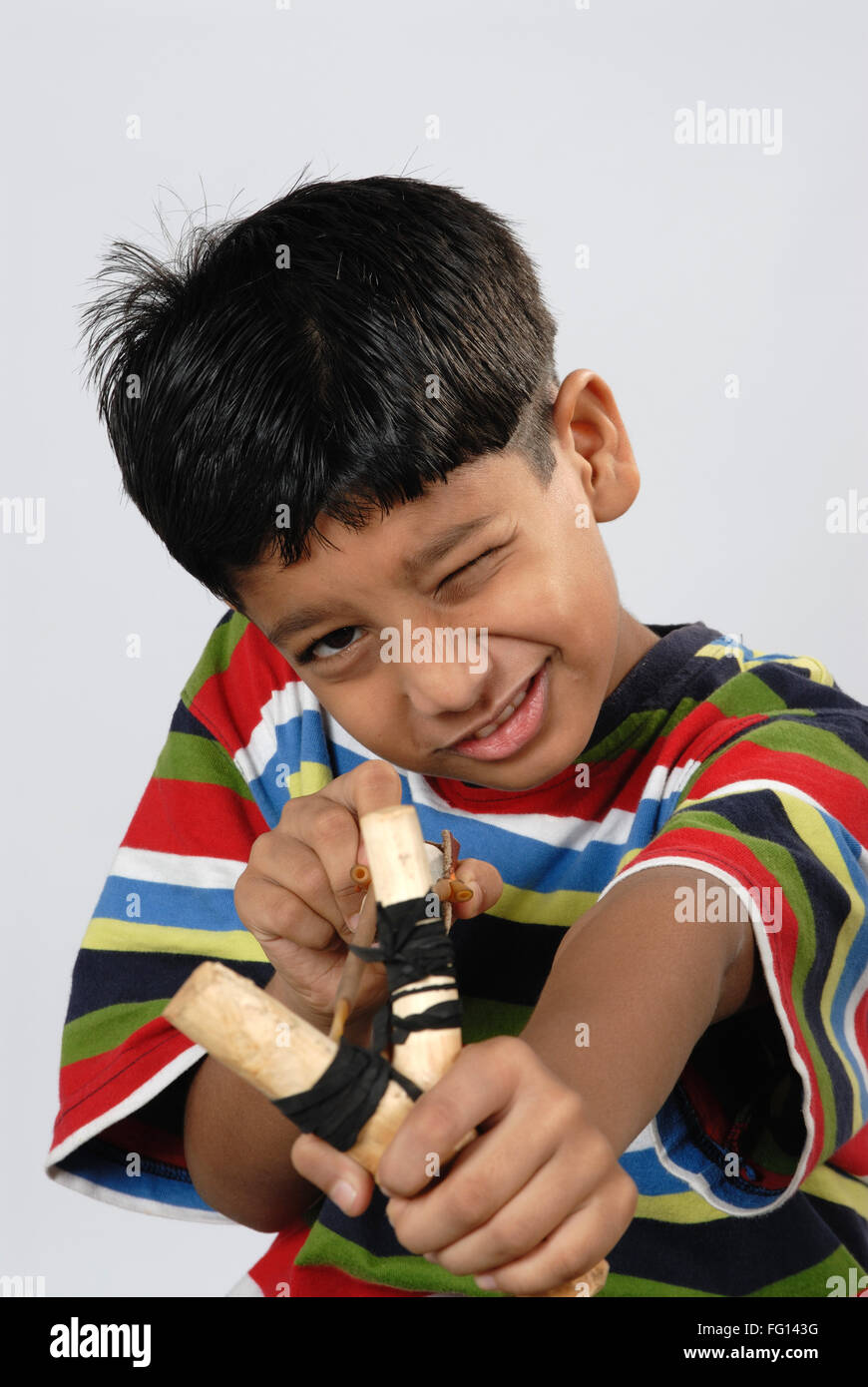 boy aiming catapult at camera MR#152 Stock Photo - Alamy