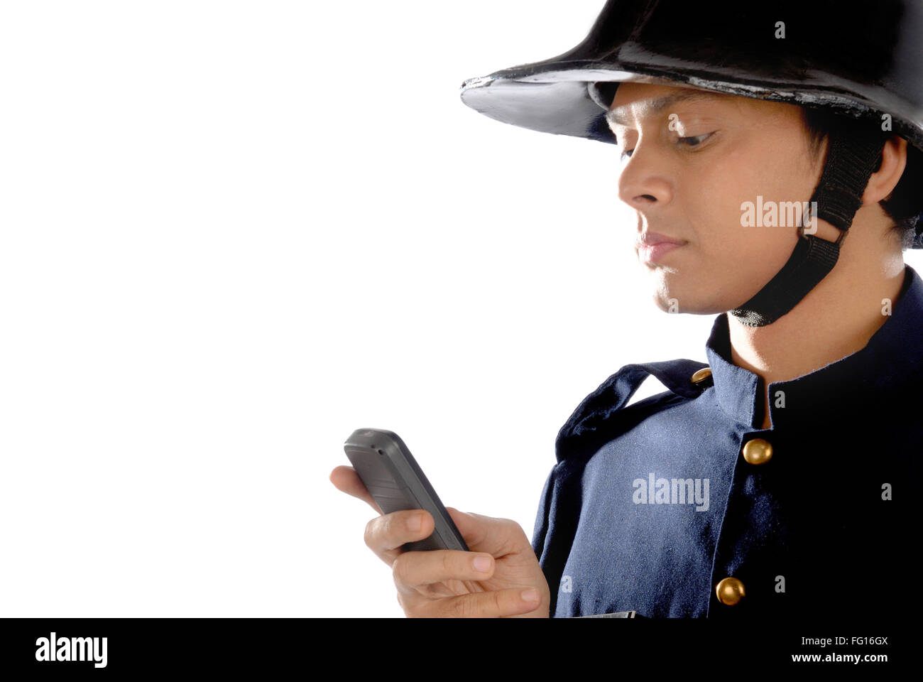 Fireman looking at mobile phone MR#782W Stock Photo - Alamy